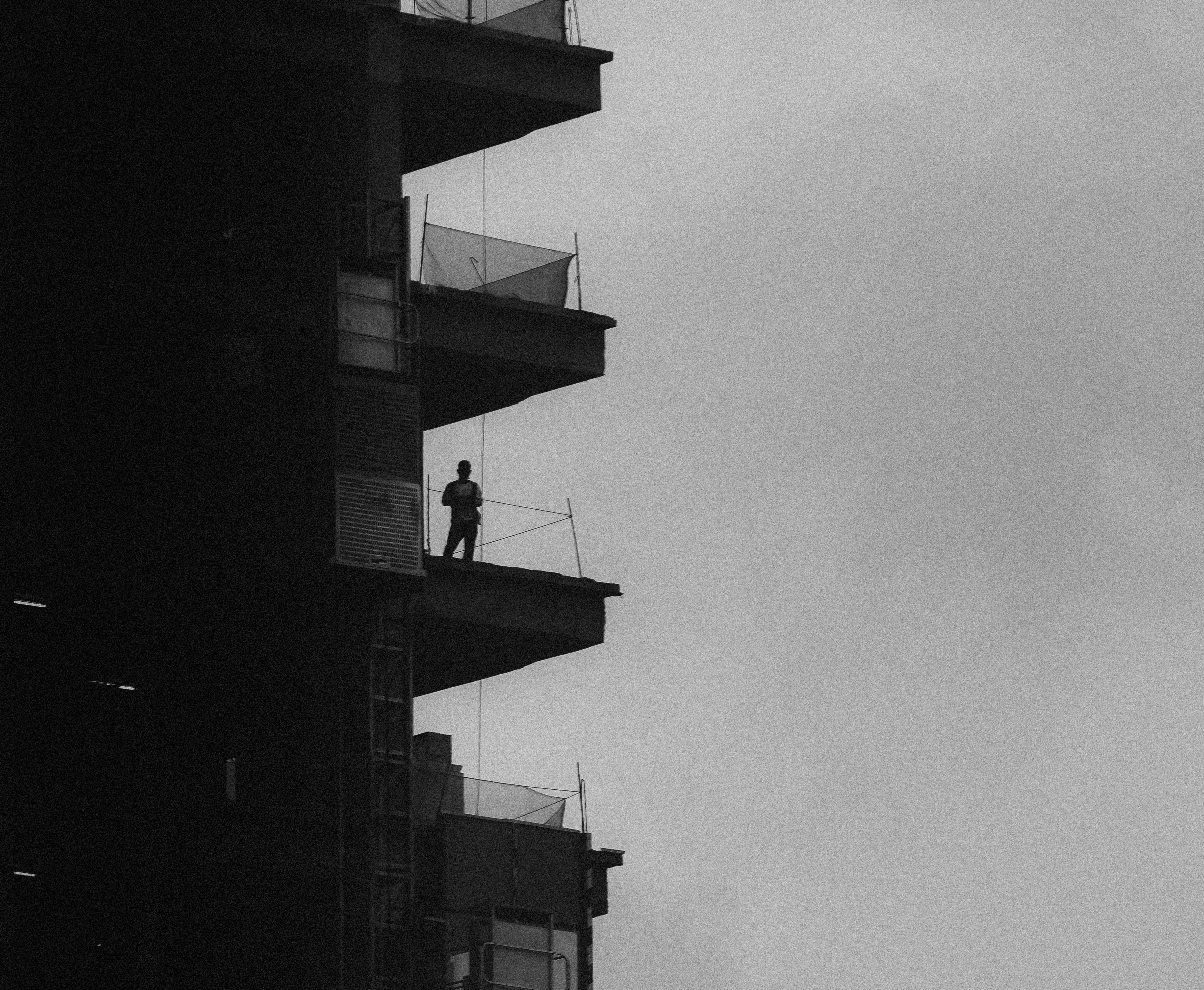 Black and White Photo of a Man in a Building · Free Stock Photo
