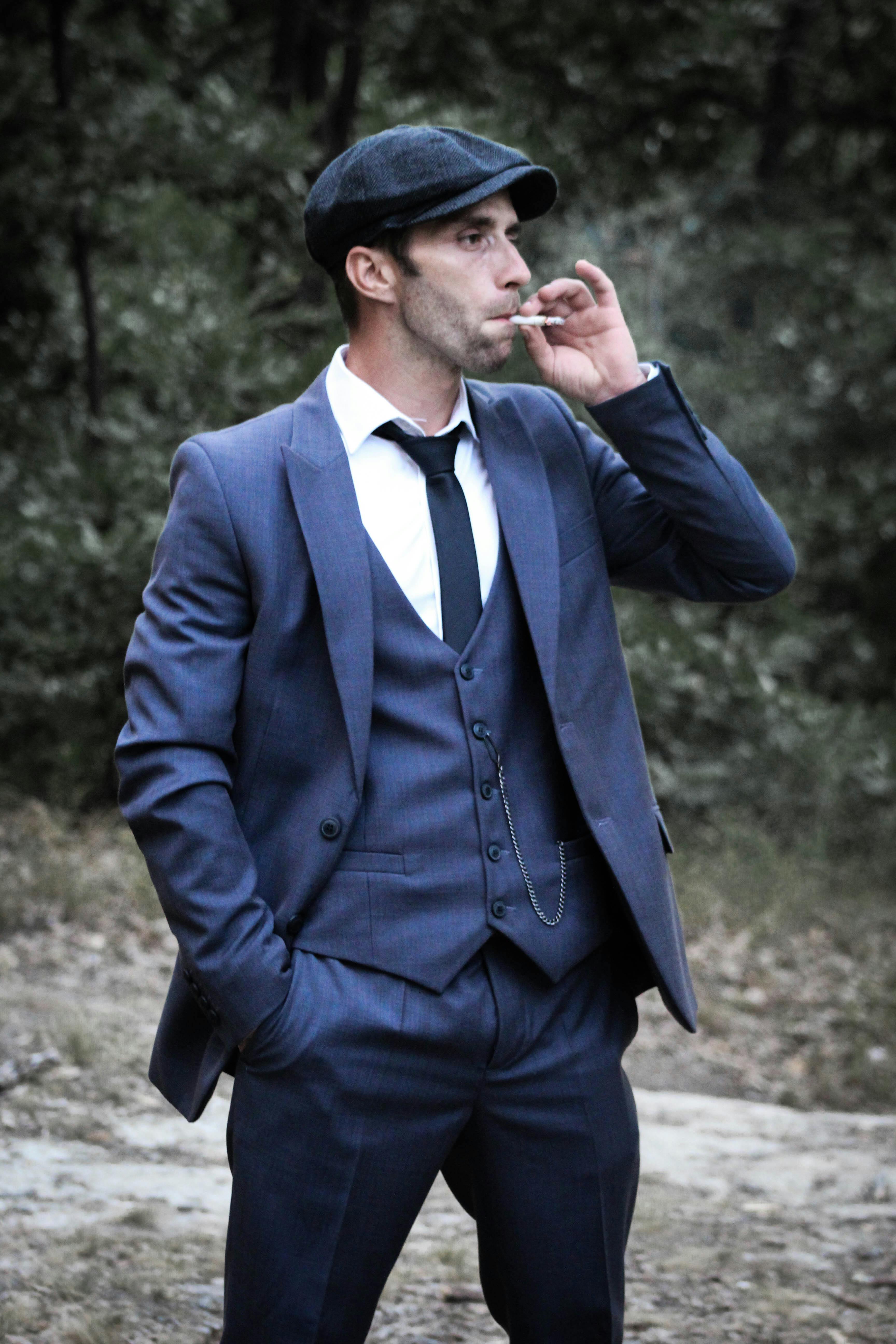 Man in Blue Suit Smoking Cigarette · Free Stock Photo