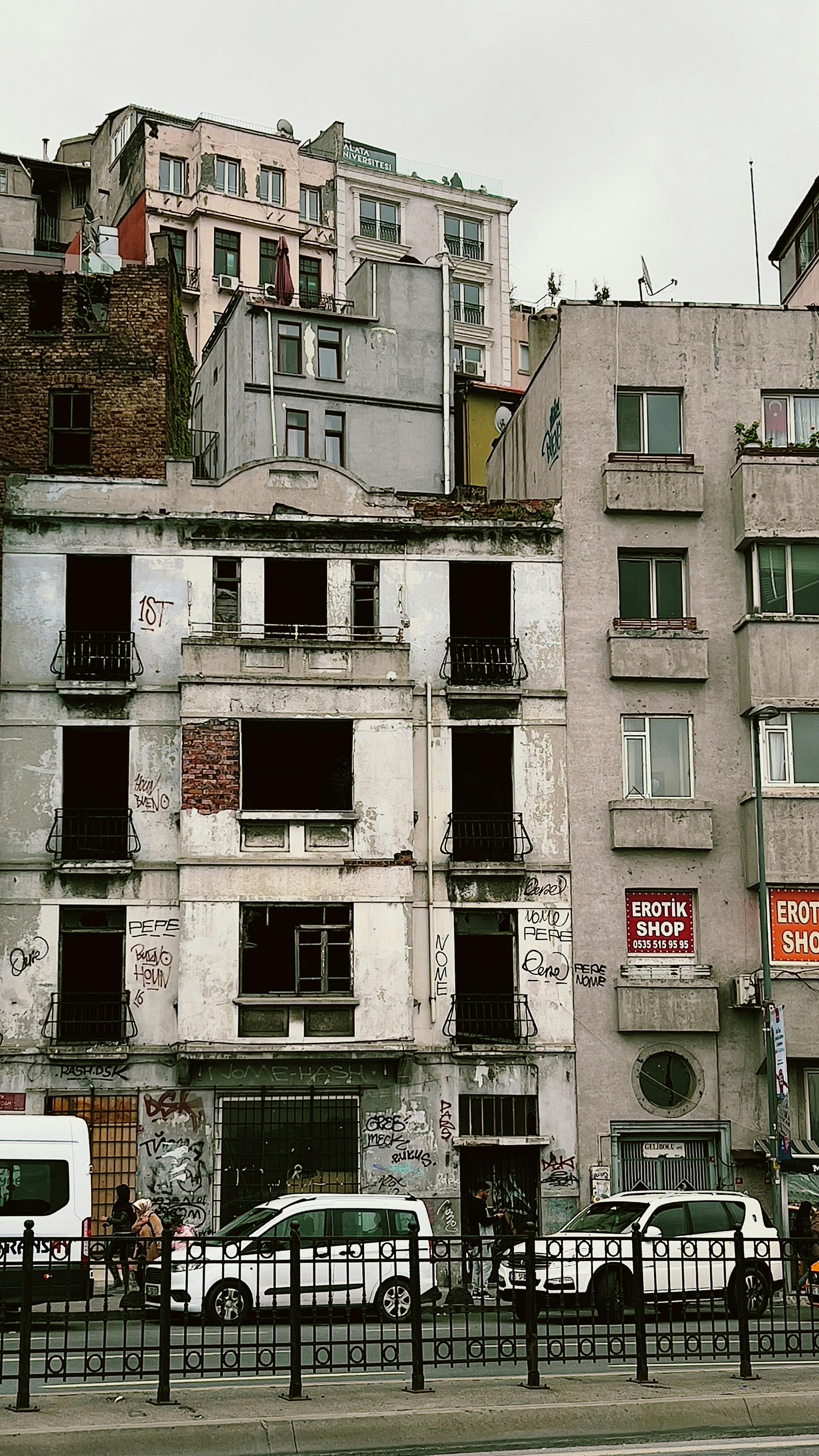 Parked Cars between the Concrete Buildings · Free Stock Photo