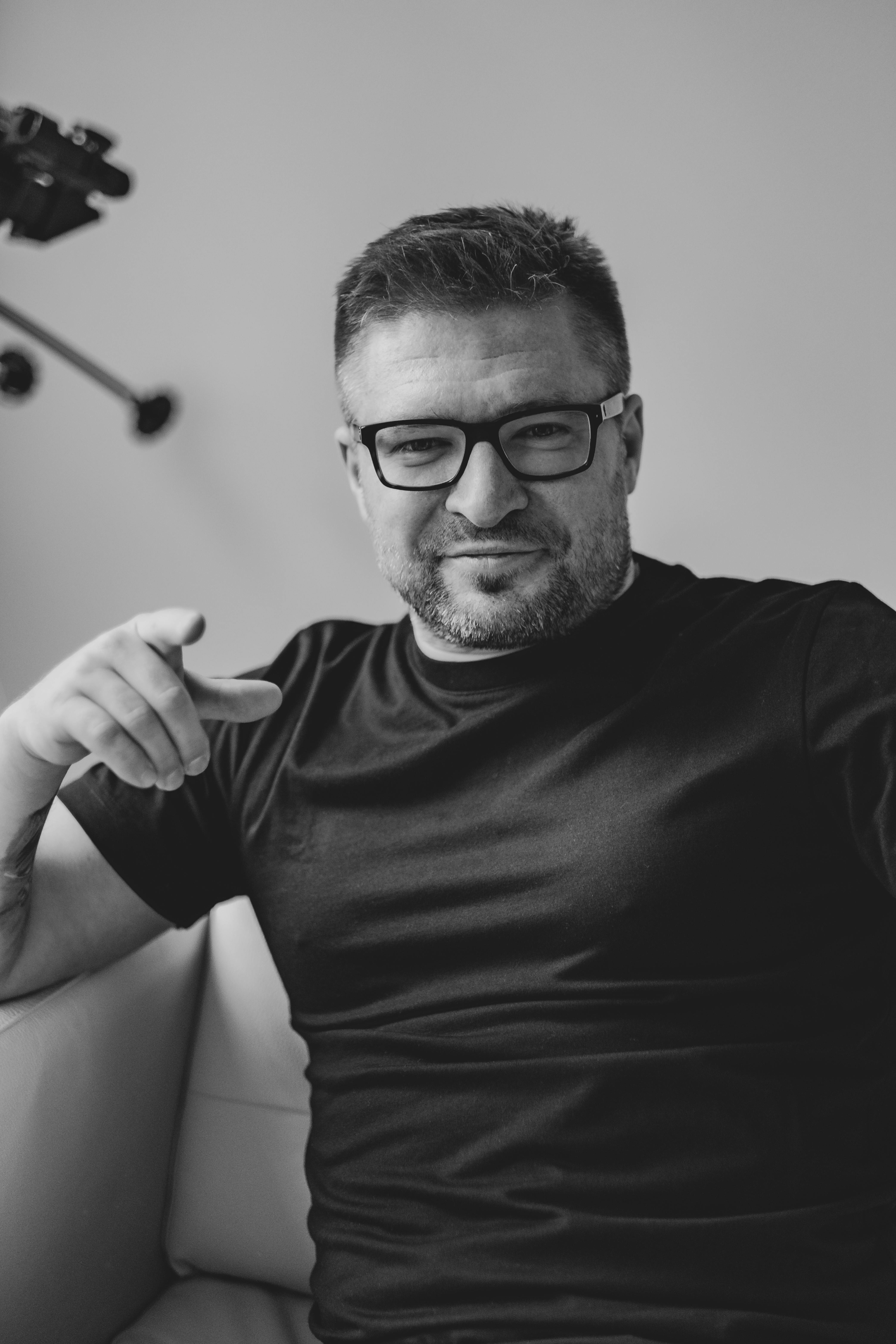 Grayscale Photography of a Man Sitting while Smiling at the Camera ...
