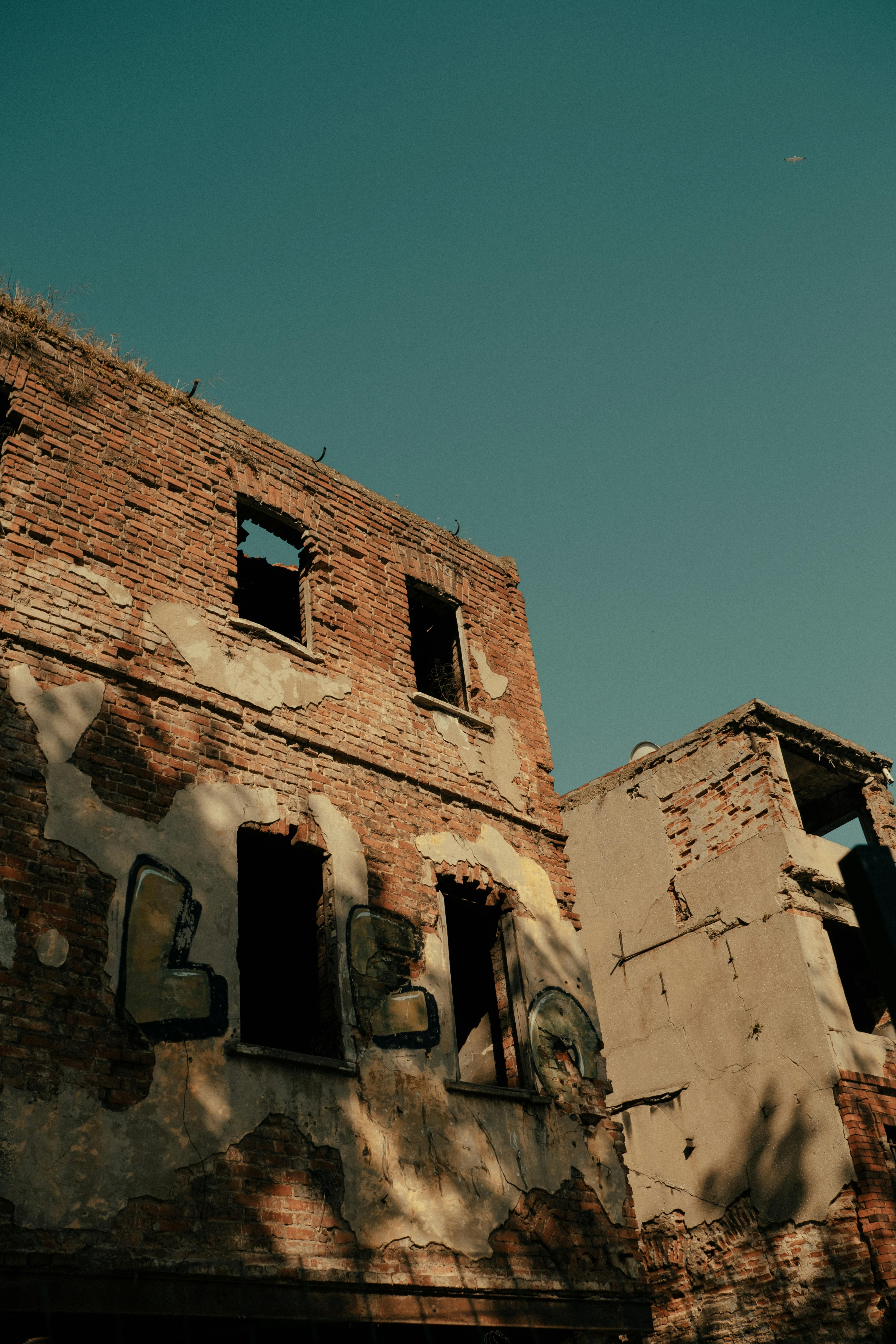 Abandoned Brick Buildings Decay on Blue Sky · Free Stock Photo