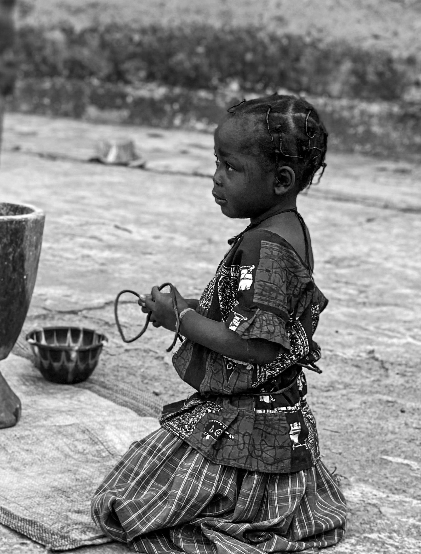 Little Girl Petting a Cat in the Street · Free Stock Photo