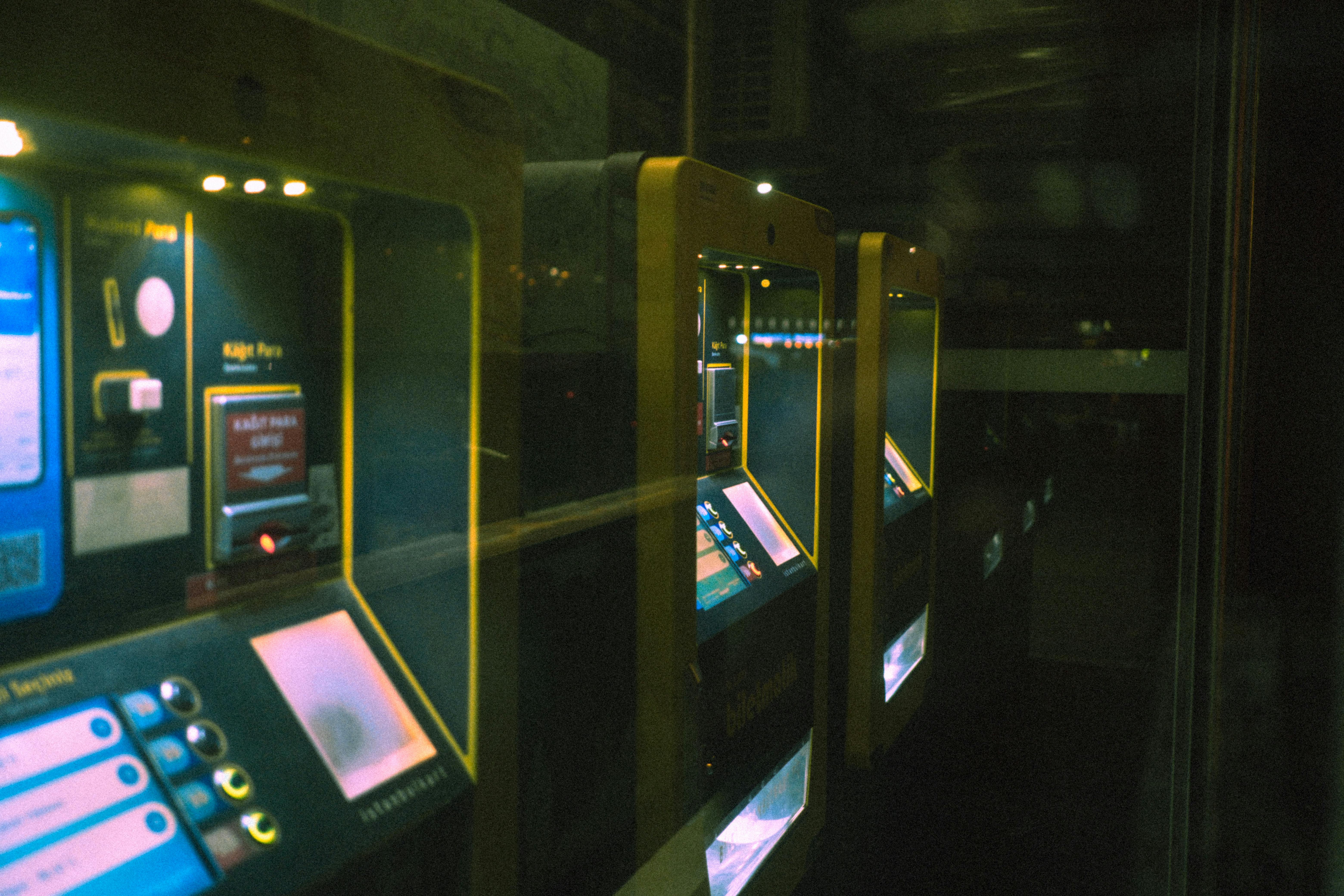 Dark Photo of Illuminated Ticket Machines · Free Stock Photo