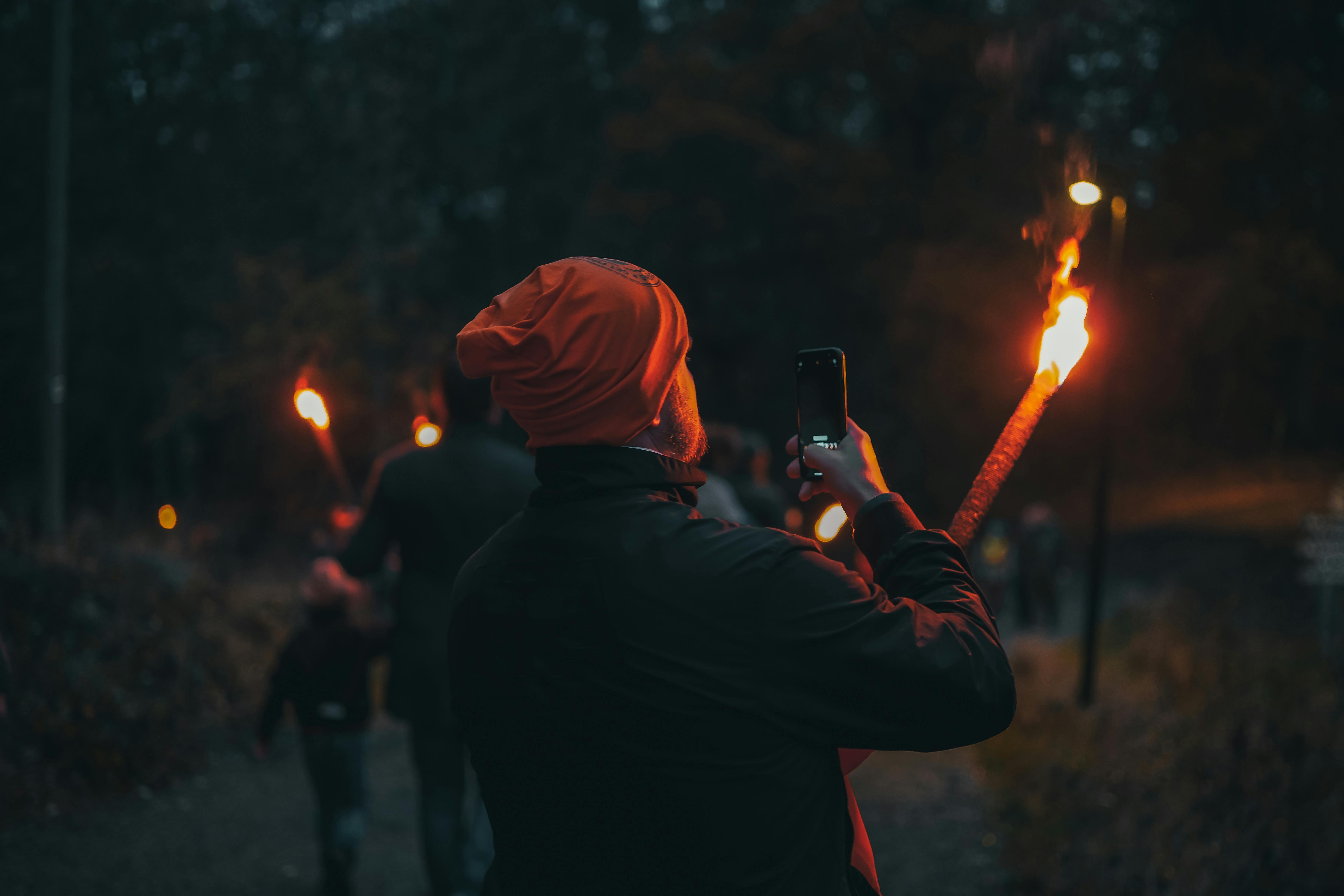 Man Taking Pictures of Torch · Free Stock Photo