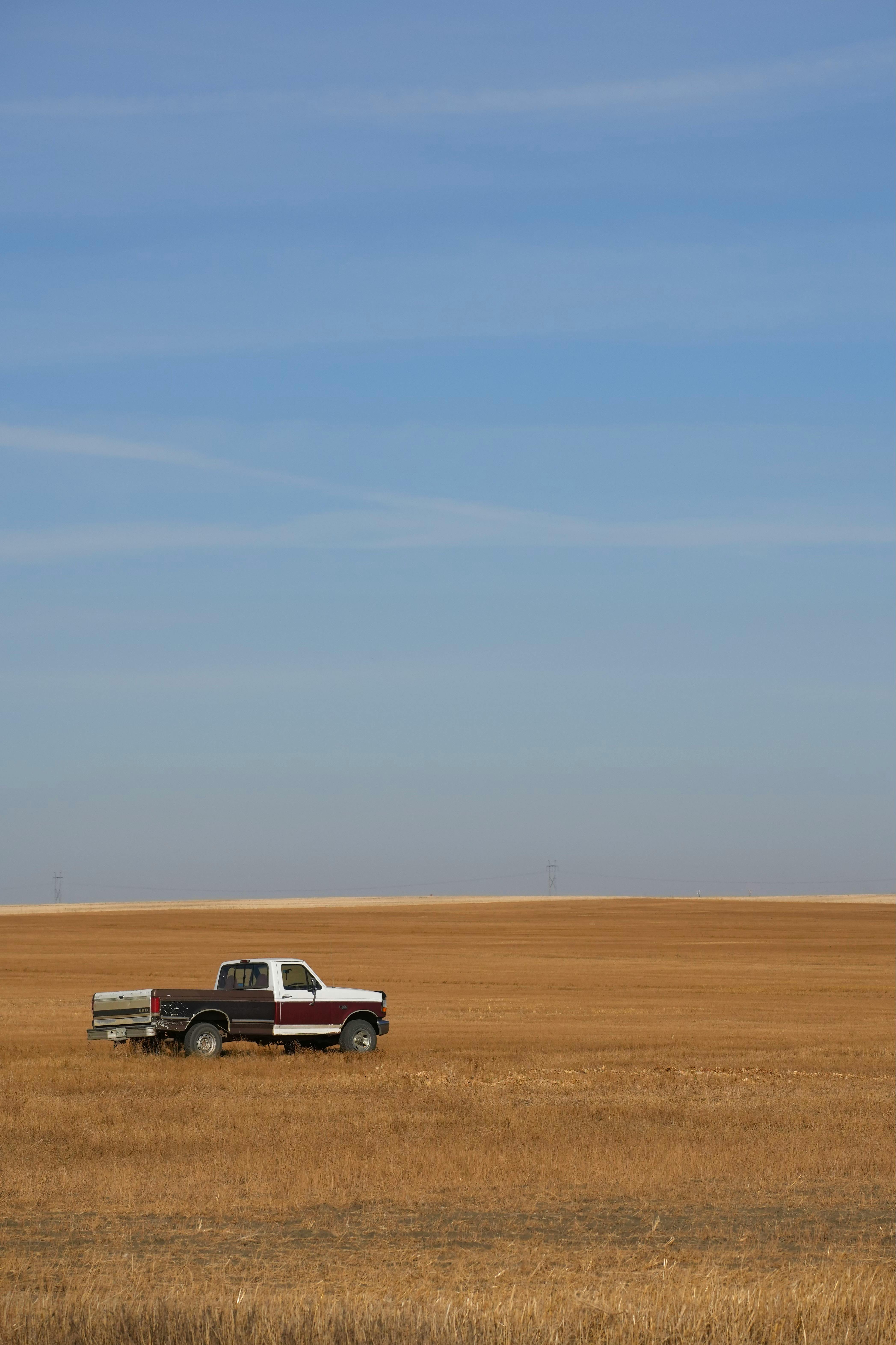 Pickup Truck Driving on Grass Field · Free Stock Photo