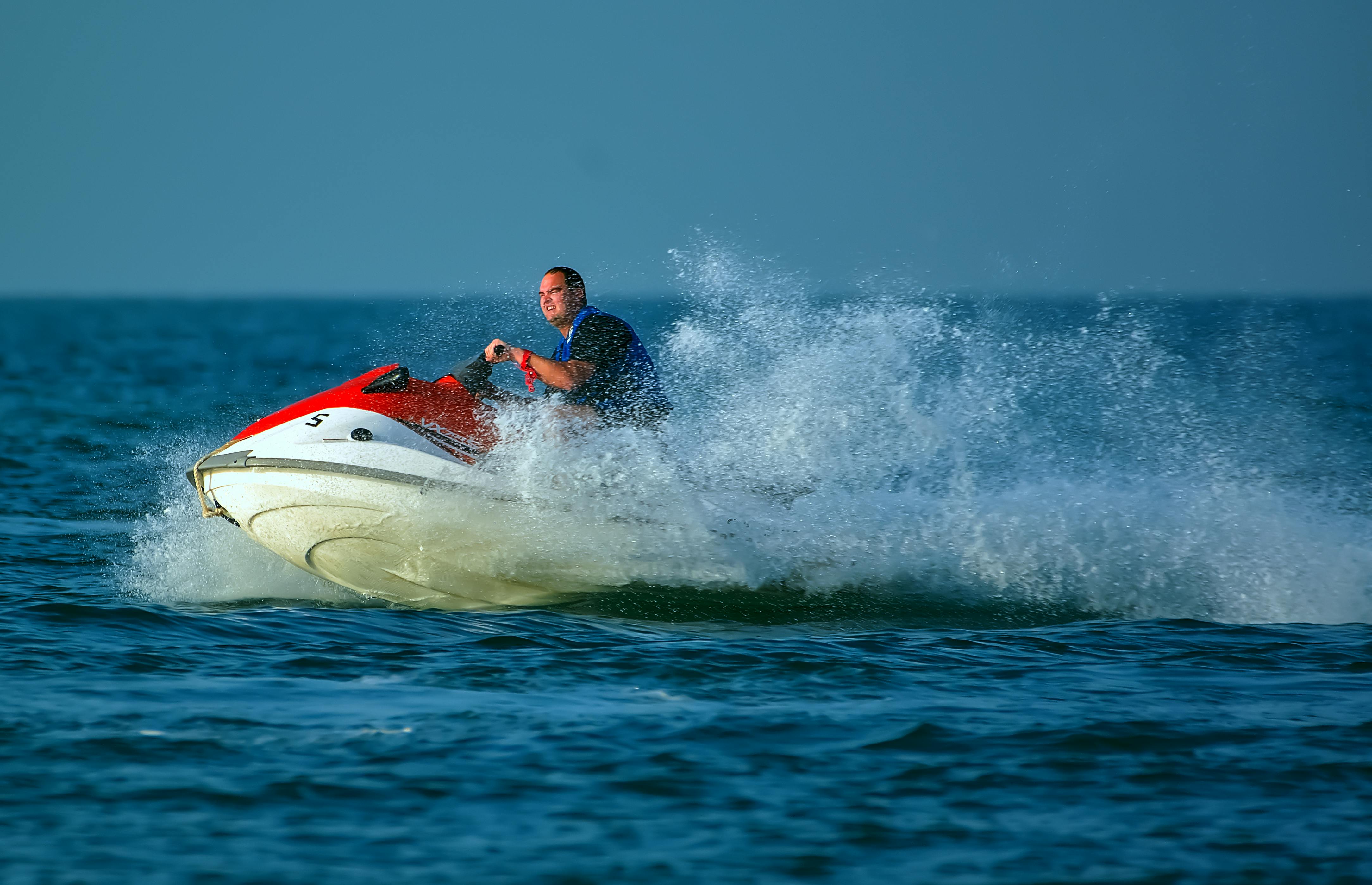 Man Riding White and Red Speedboat · Free Stock Photo