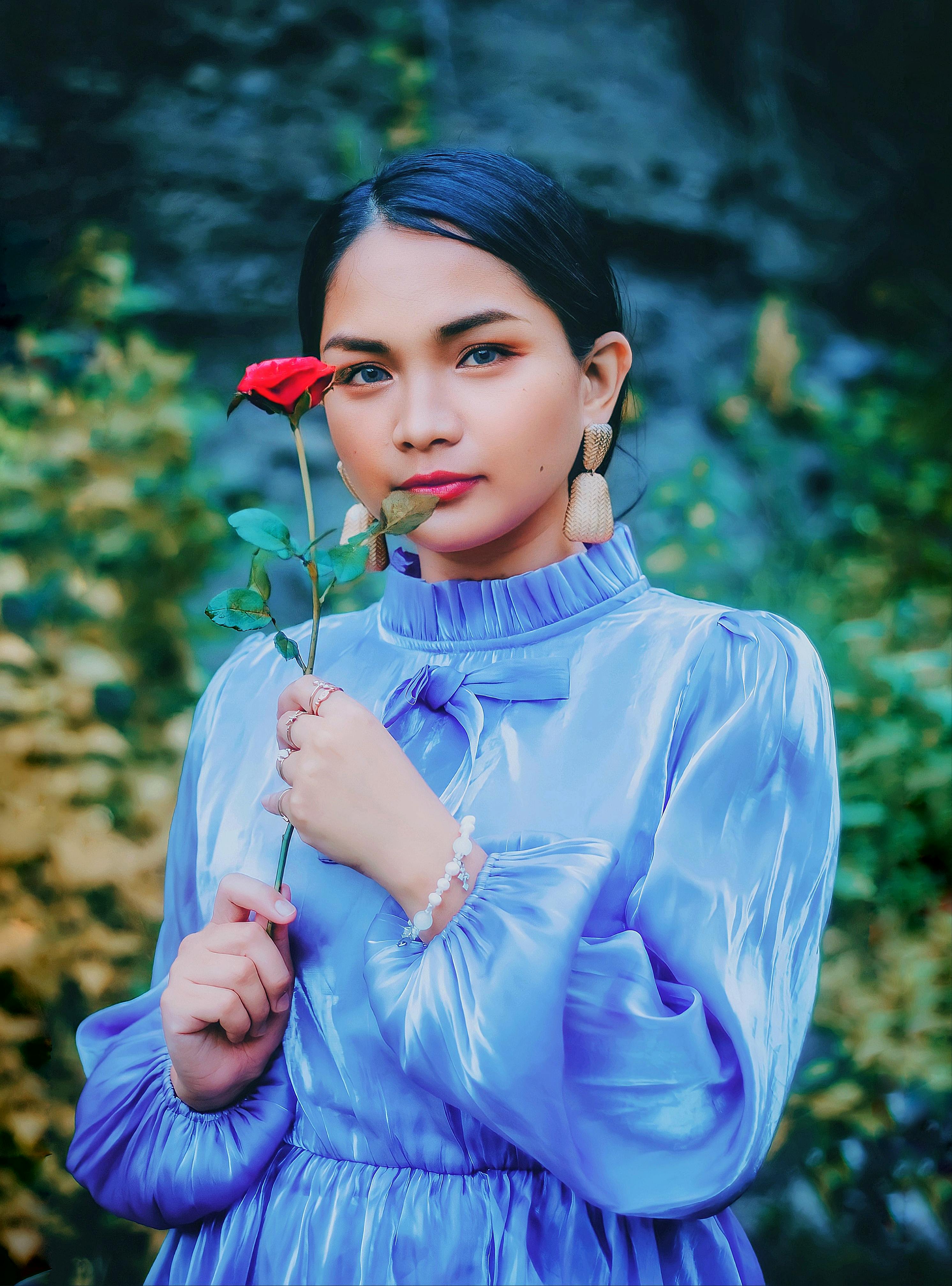 Portrait of a Girl Holding a Rose · Free Stock Photo