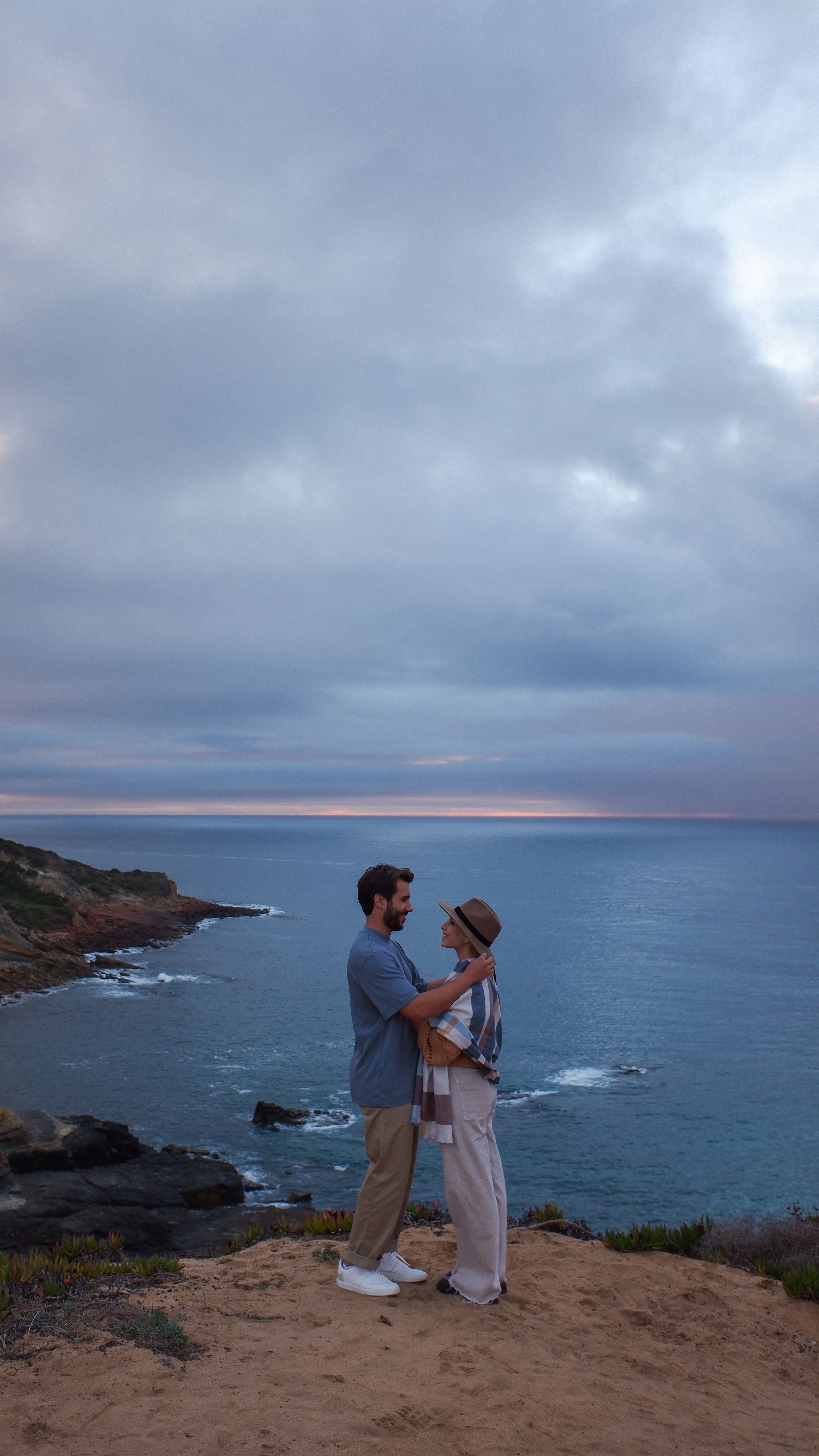 A Couple Standing on the Cliff Near Sea · Free Stock Photo