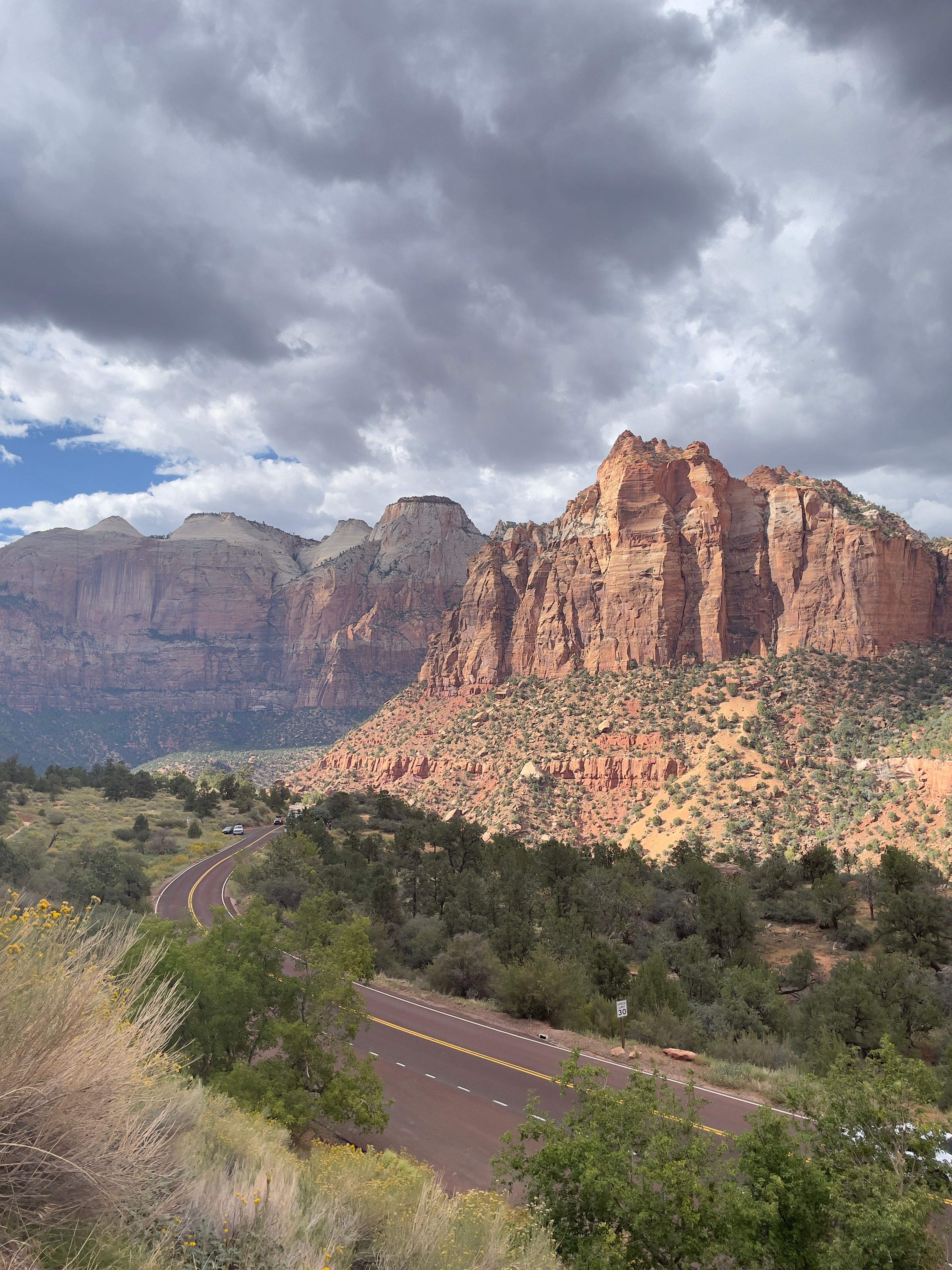 Eroded Cliff Rocks Towering over Road · Free Stock Photo