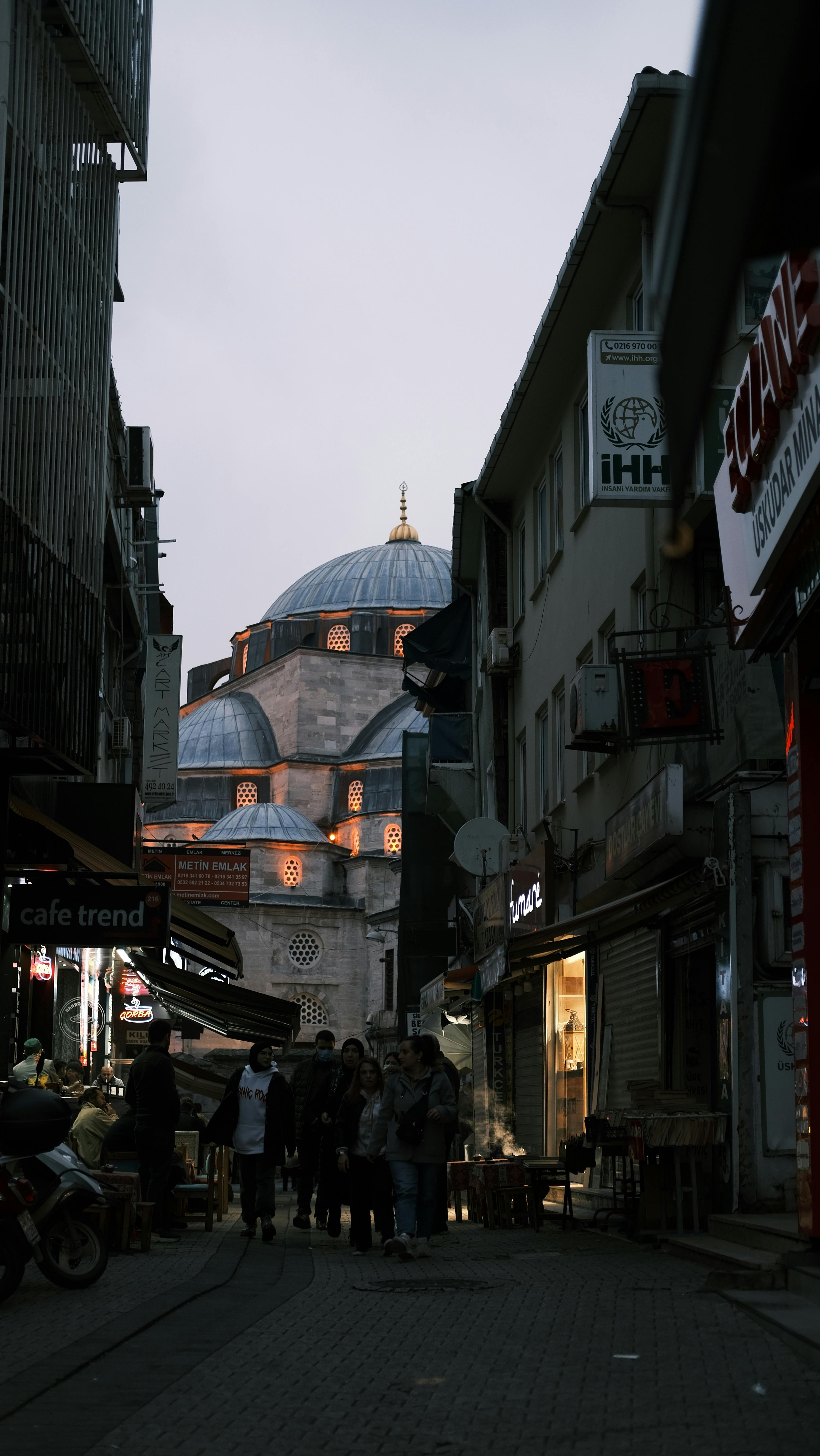 People Walking on the Street between Buildings · Free Stock Photo