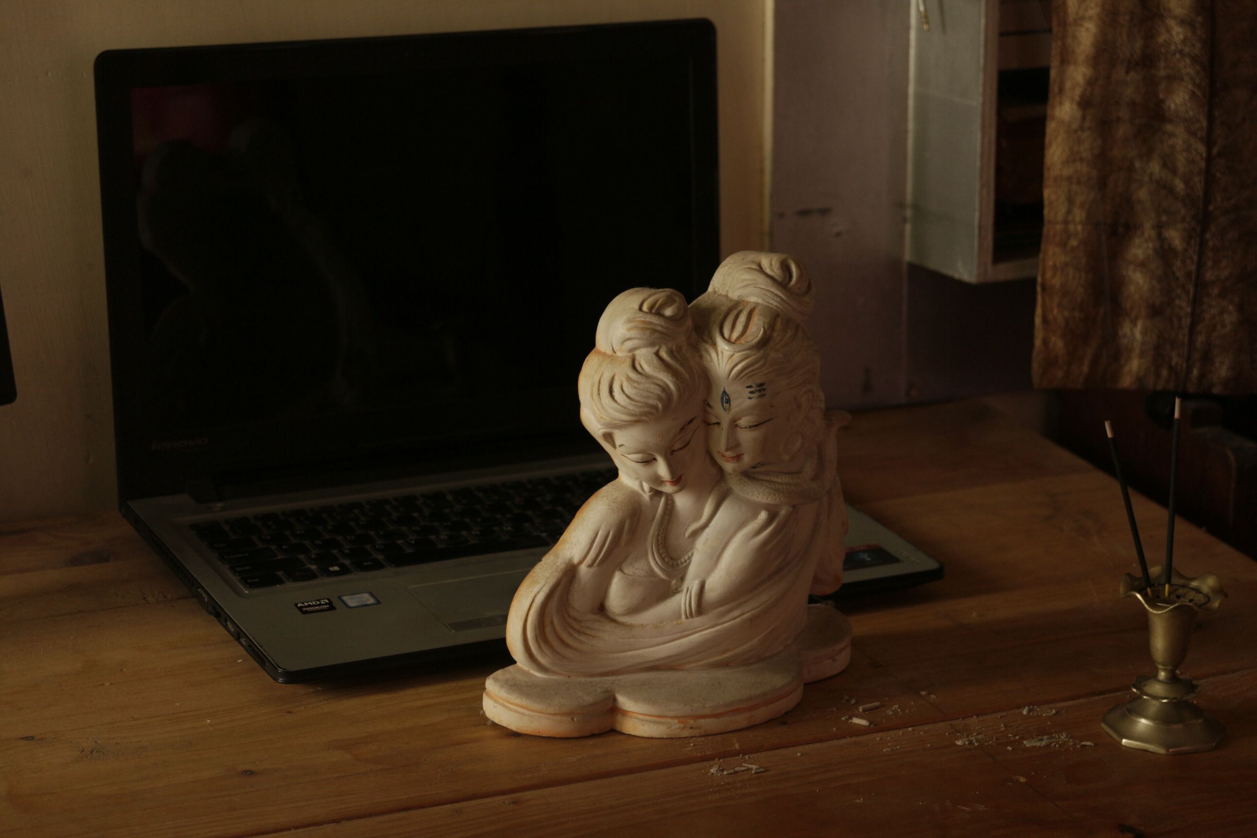 Carved Figurine by Laptop · Free Stock Photo