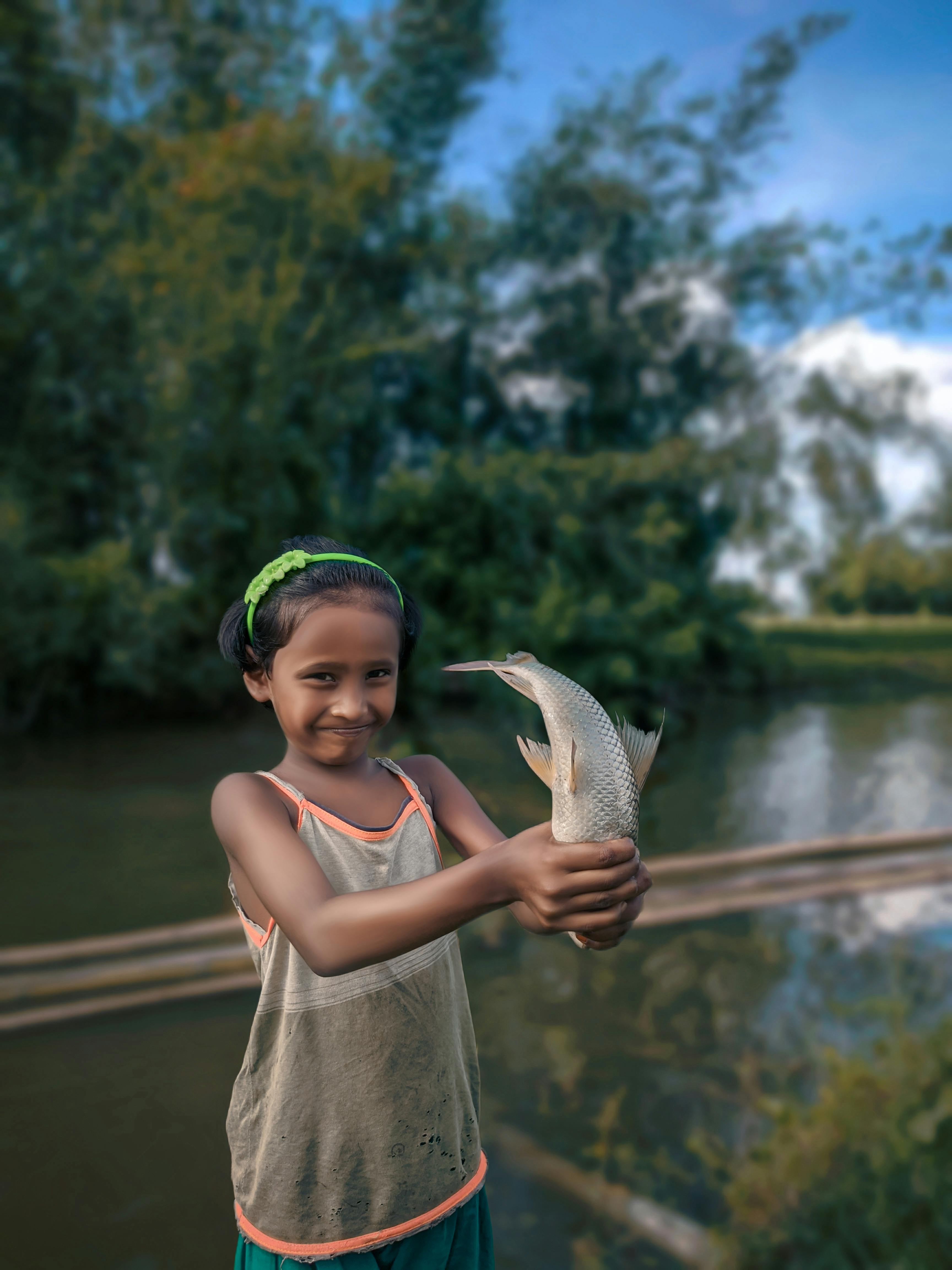 Photo of a Girl Holding a Fish · Free Stock Photo