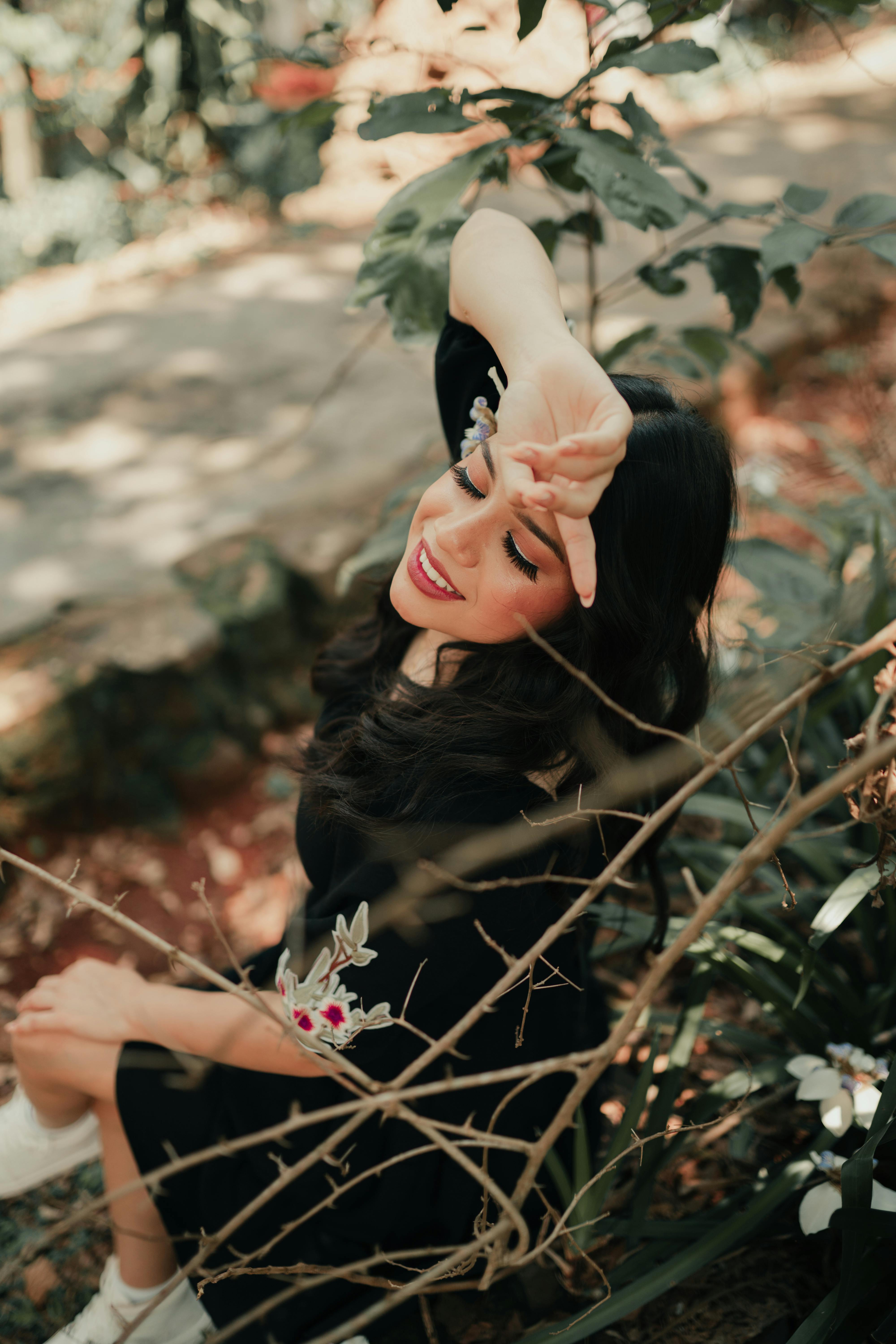 High-Angle Shot of a Girl Posing with Her Hand on Her Head · Free Stock ...