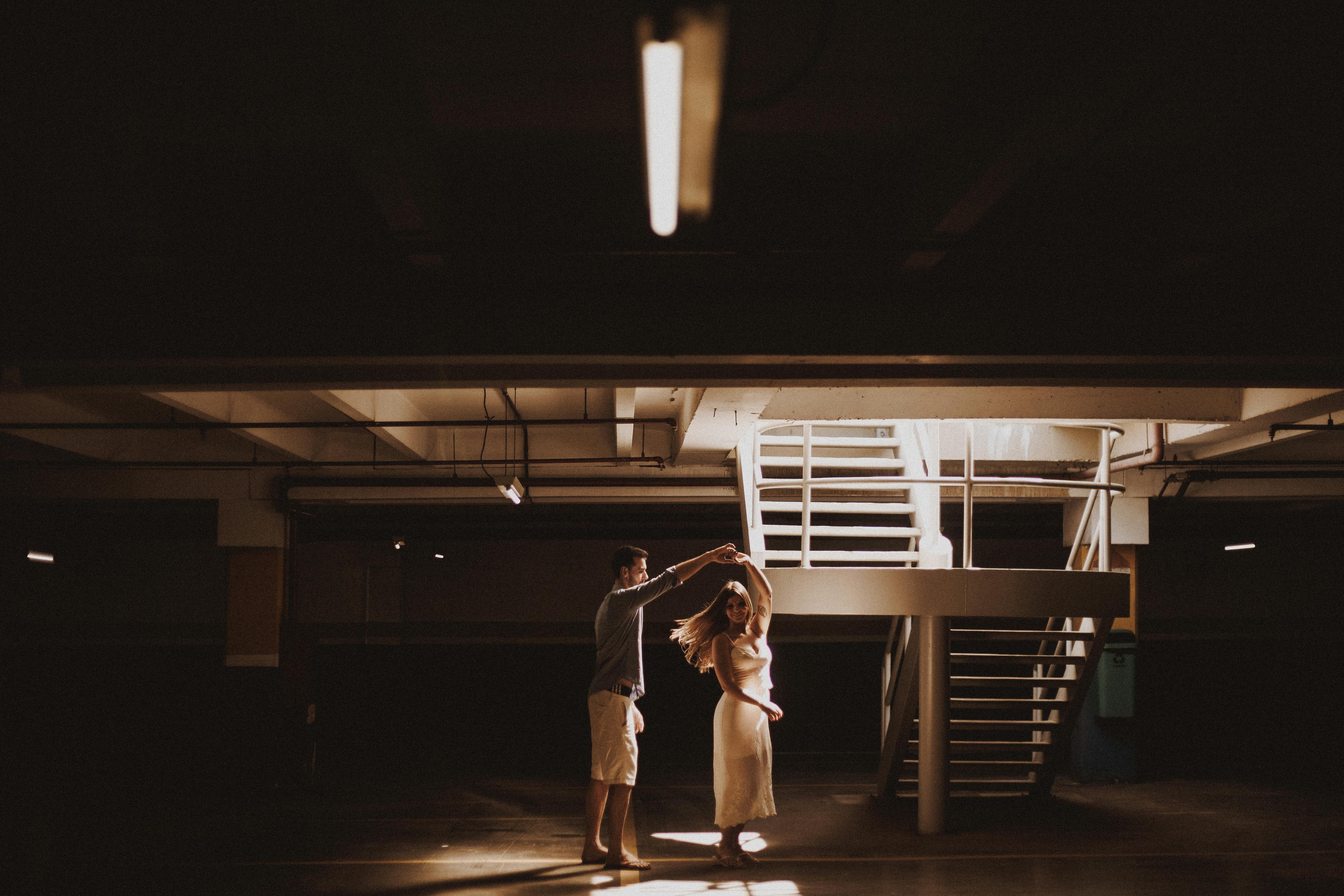 A Man and a Woman Dancing Near a Staircase · Free Stock Photo