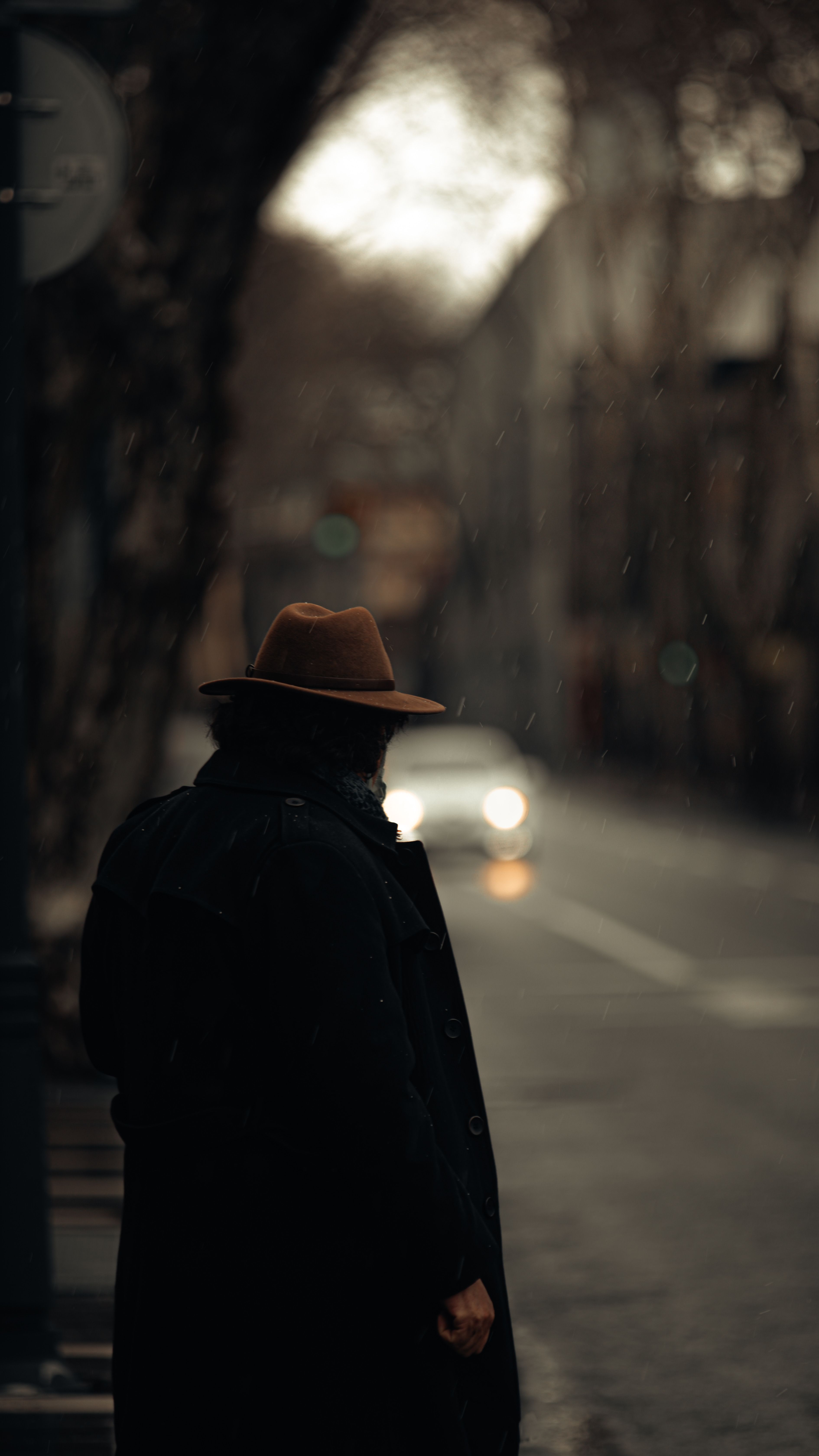 Person Wearing Hat Standing on Sidewalk · Free Stock Photo
