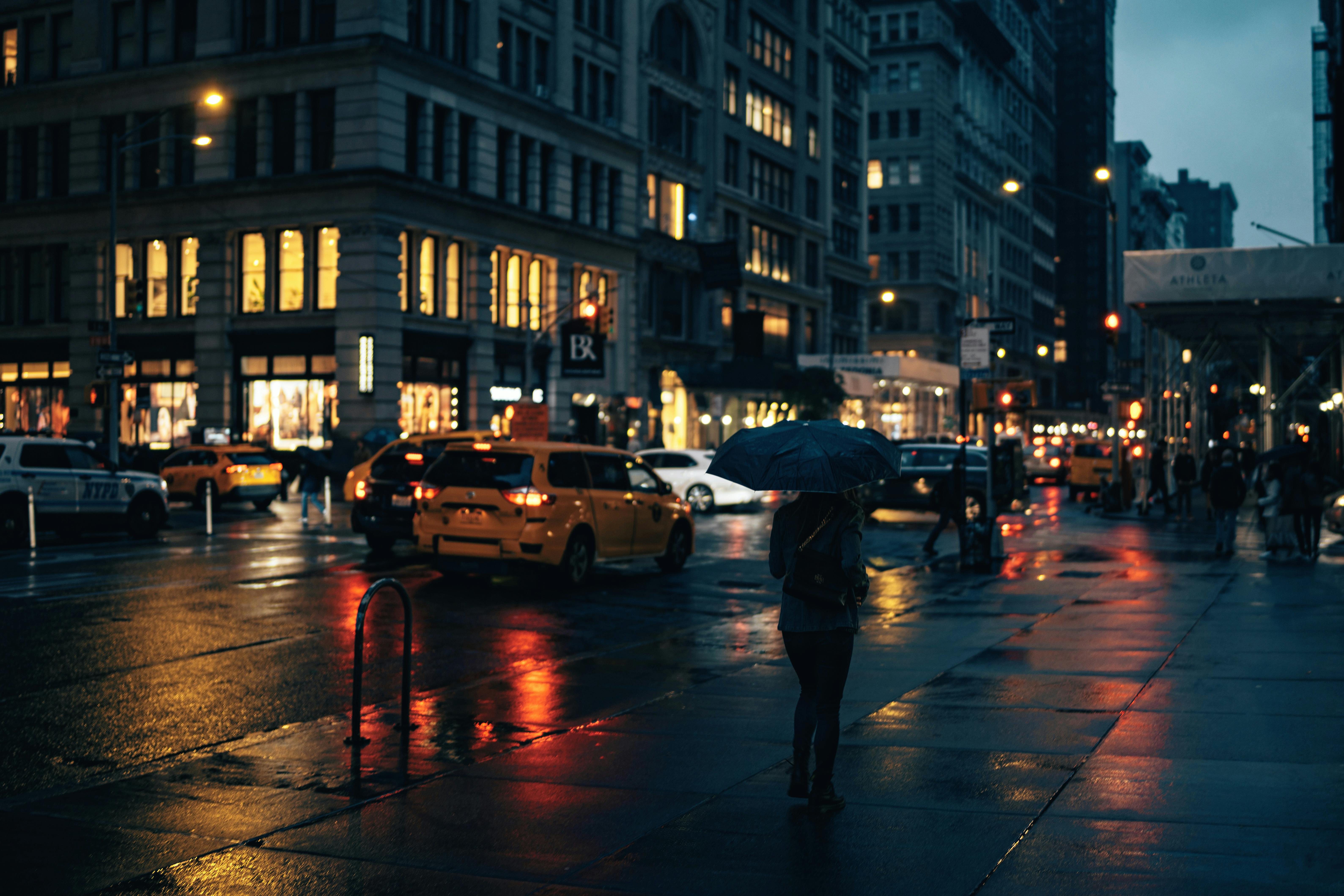 A Woman Walking on the Street During Night Time · Free Stock Photo