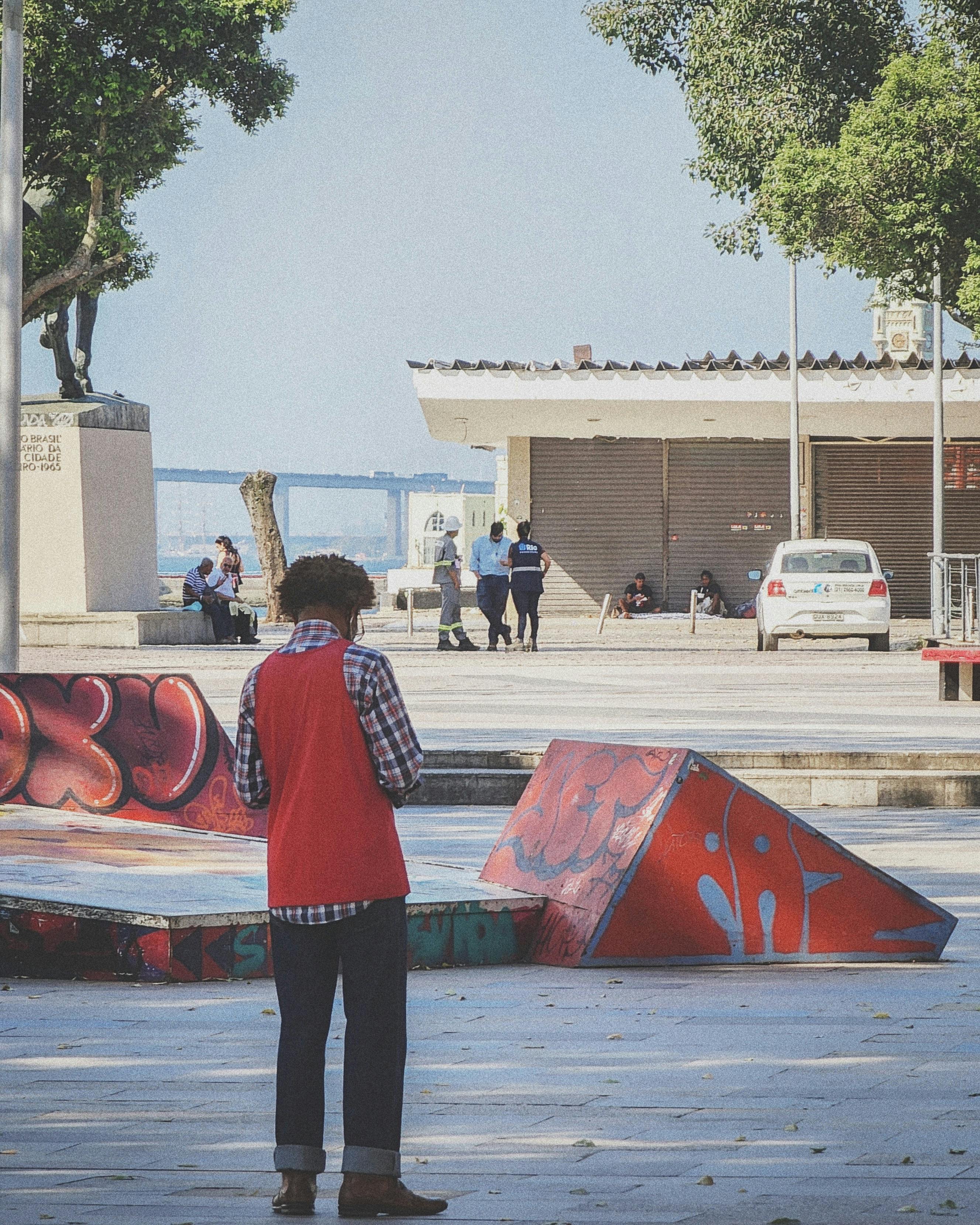 Back View of an Artist Doing Graffiti · Free Stock Photo