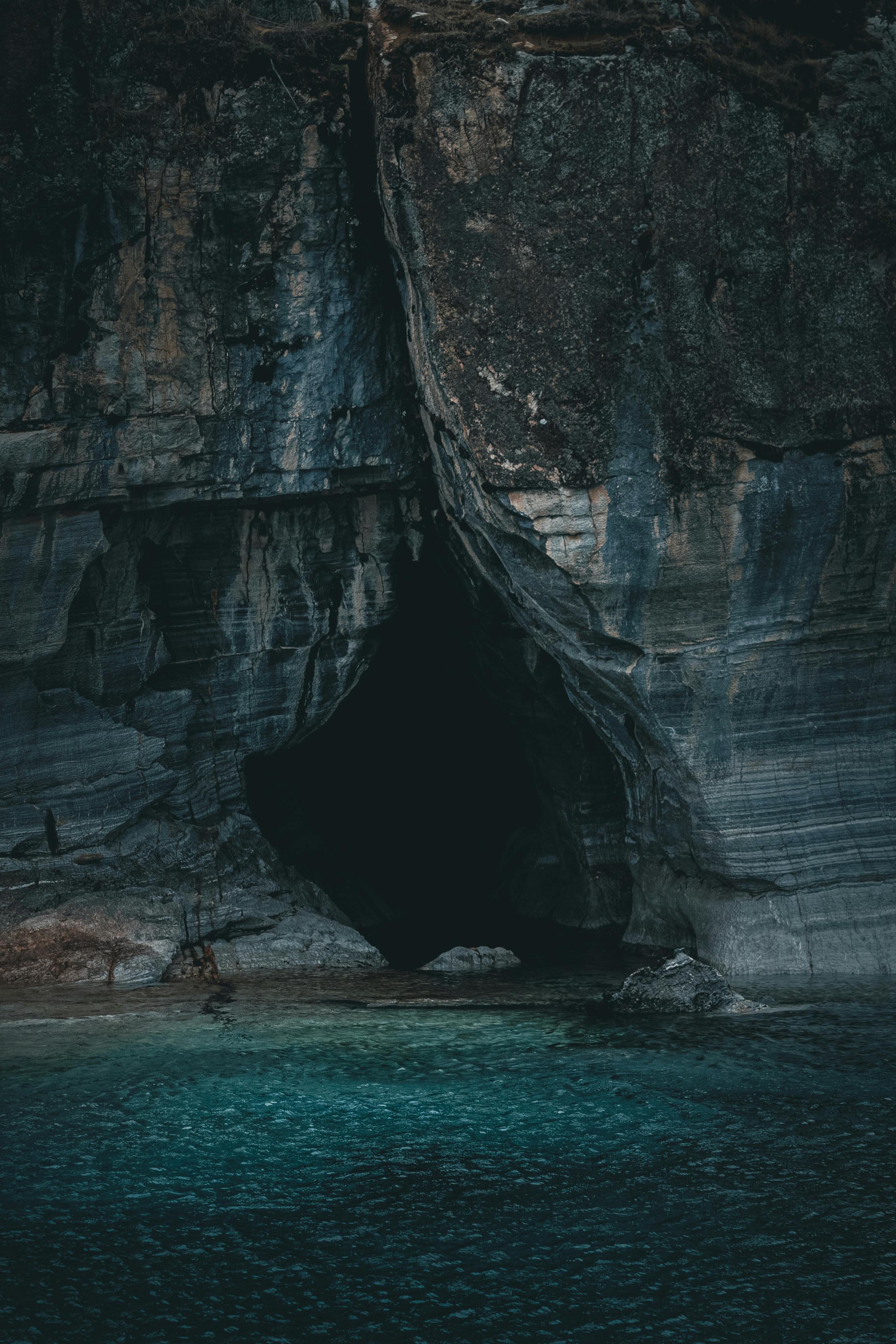 Photo of a Cliff with a Cave · Free Stock Photo