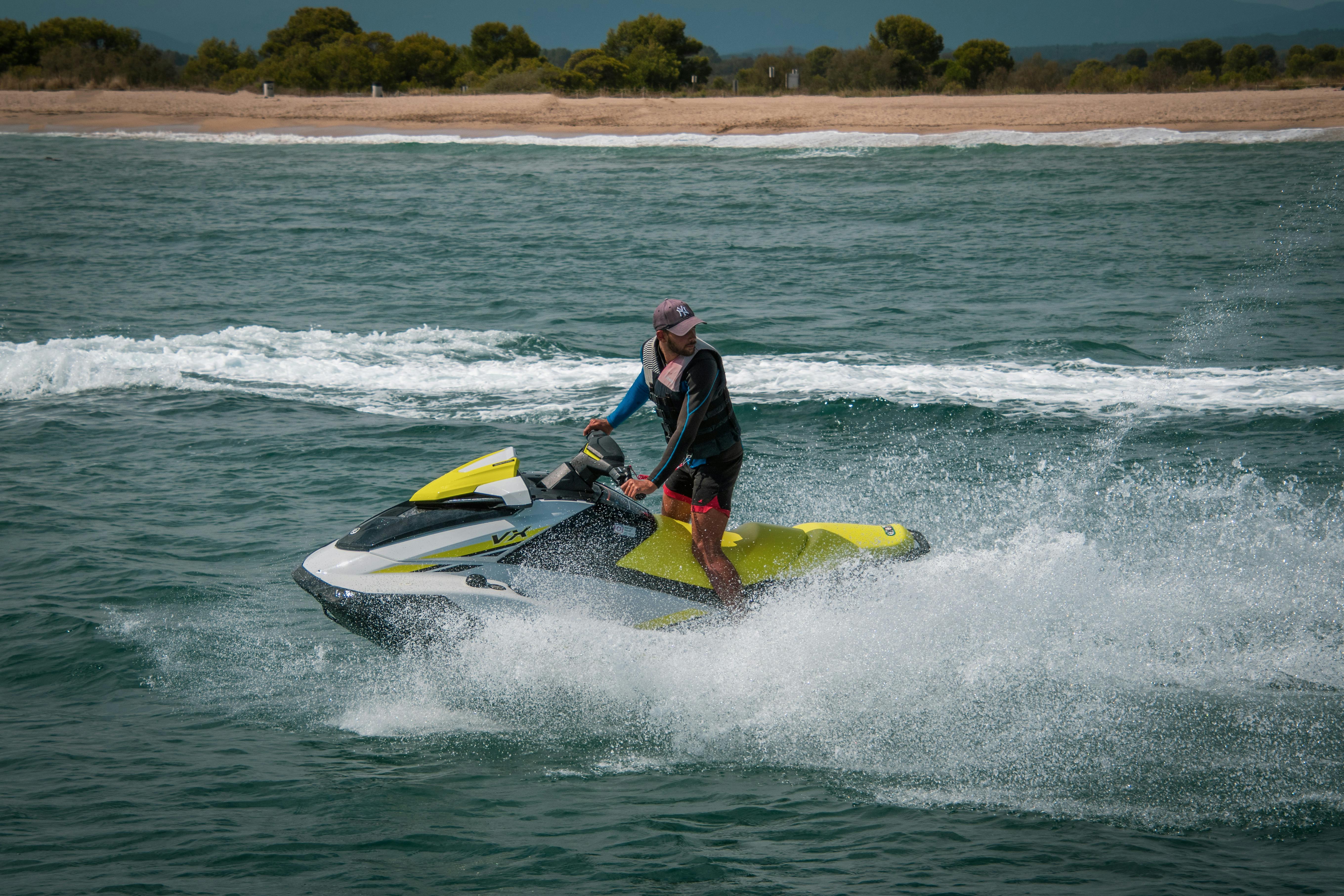 A Man Riding a Water Scooter · Free Stock Photo
