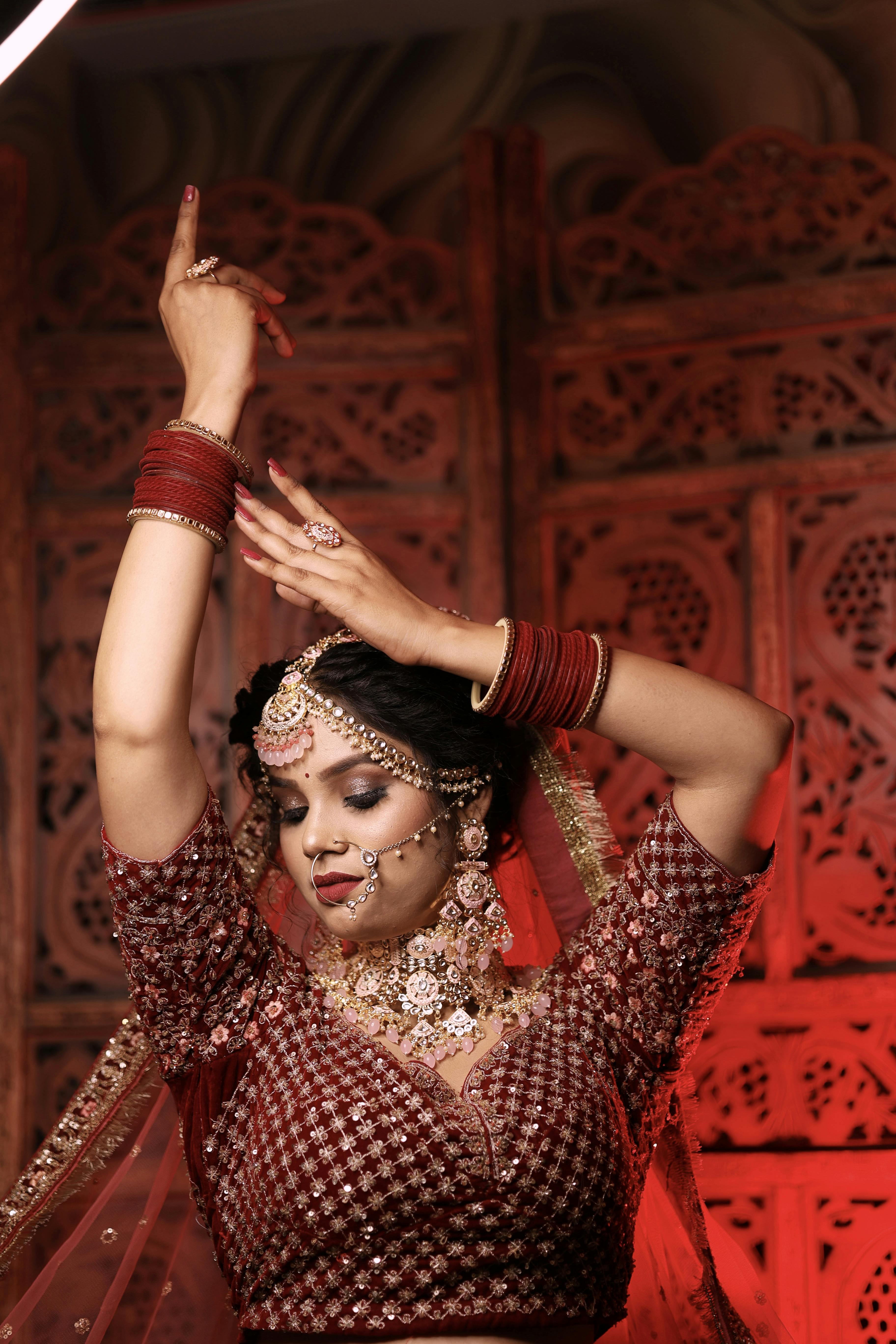 A Beautiful Woman Wearing Red Traditional Lehenga · Free Stock Photo