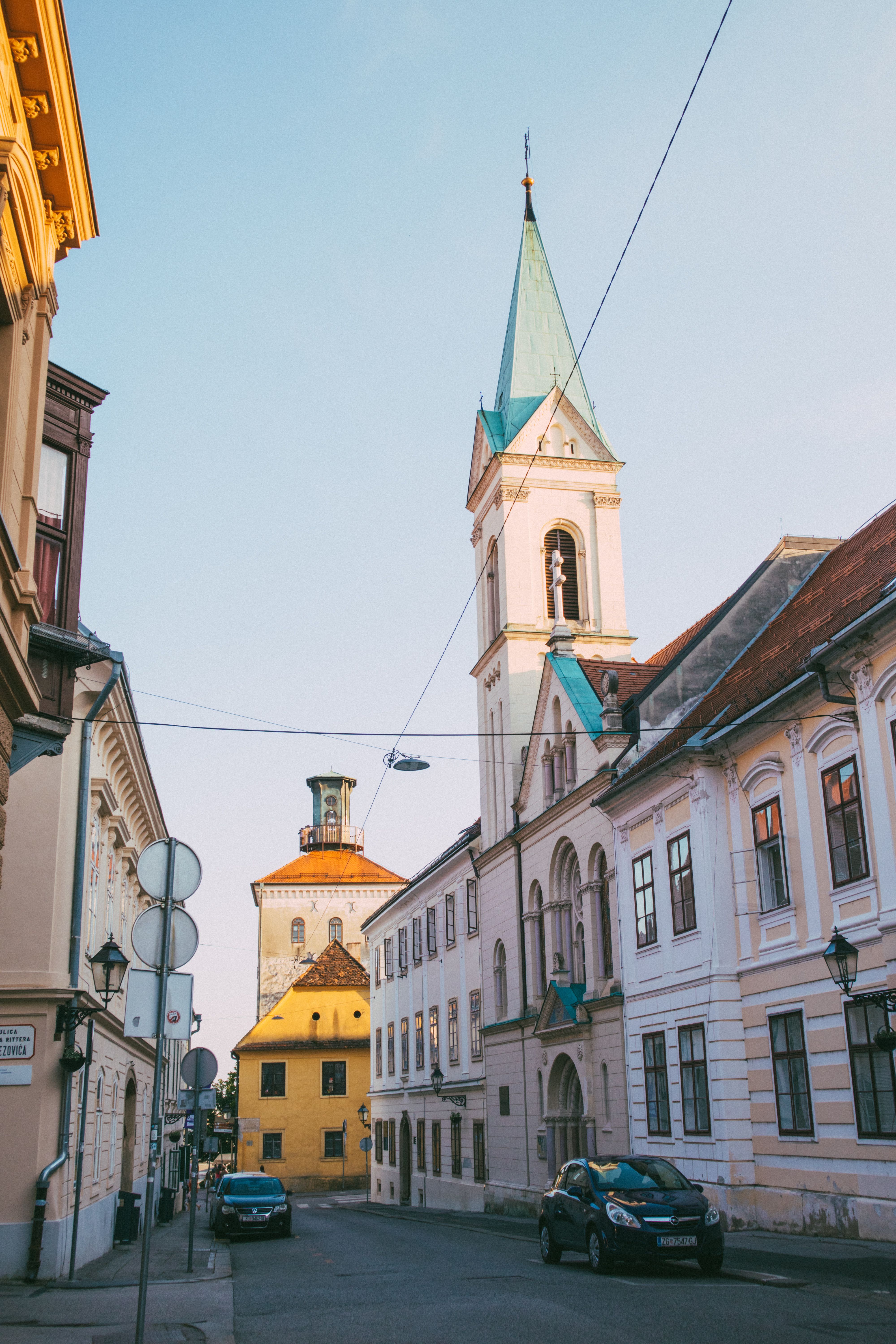 A church tower in the middle of a street · Free Stock Photo