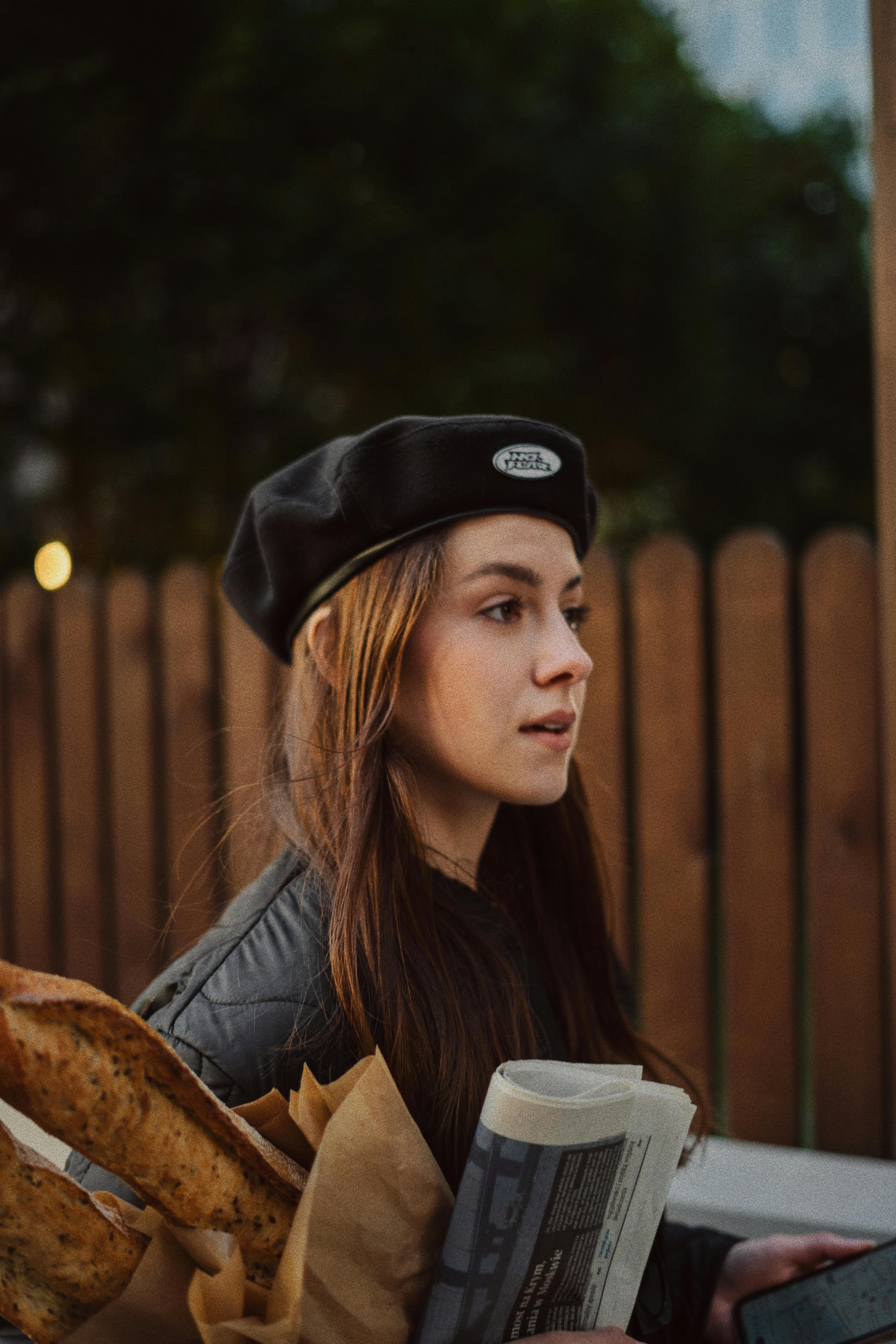 Woman in a Beret Carrying Bread and a Newspaper · Free Stock Photo