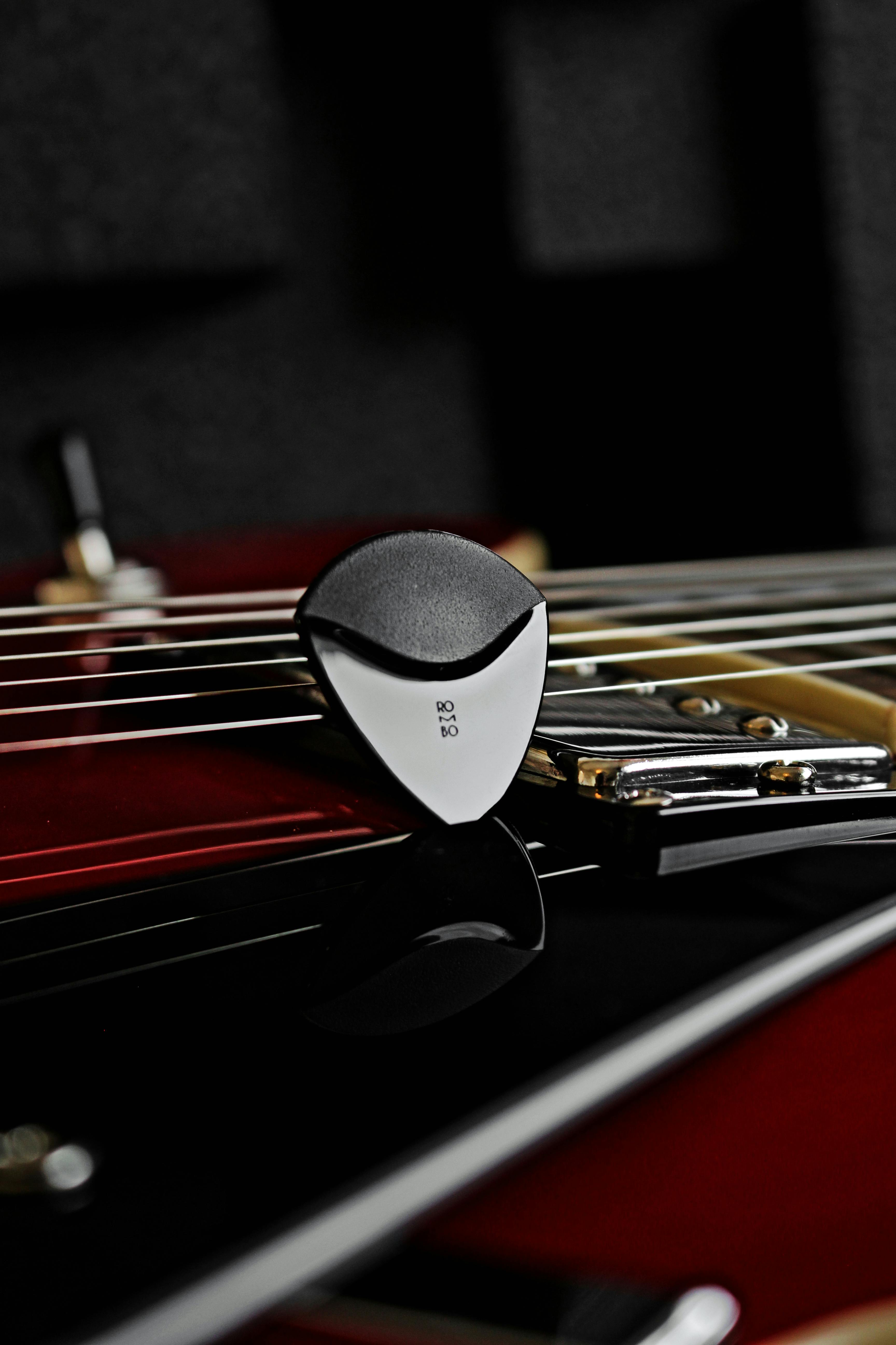 Guitar Pick laying on Fret Board and Guitar Gear · Free Stock Photo