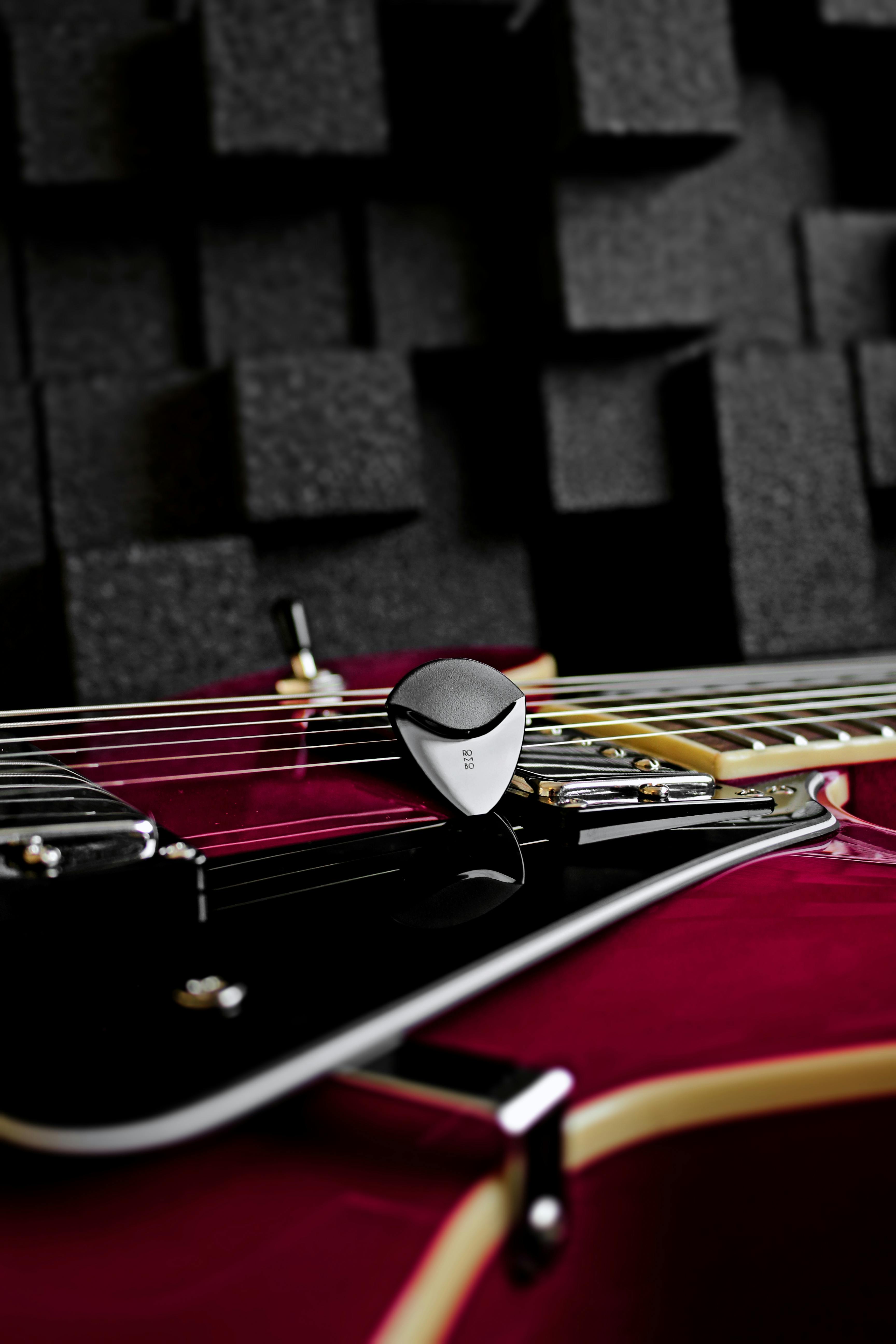 A Close-Up Shot of a Guitar Pick on a Guitar · Free Stock Photo