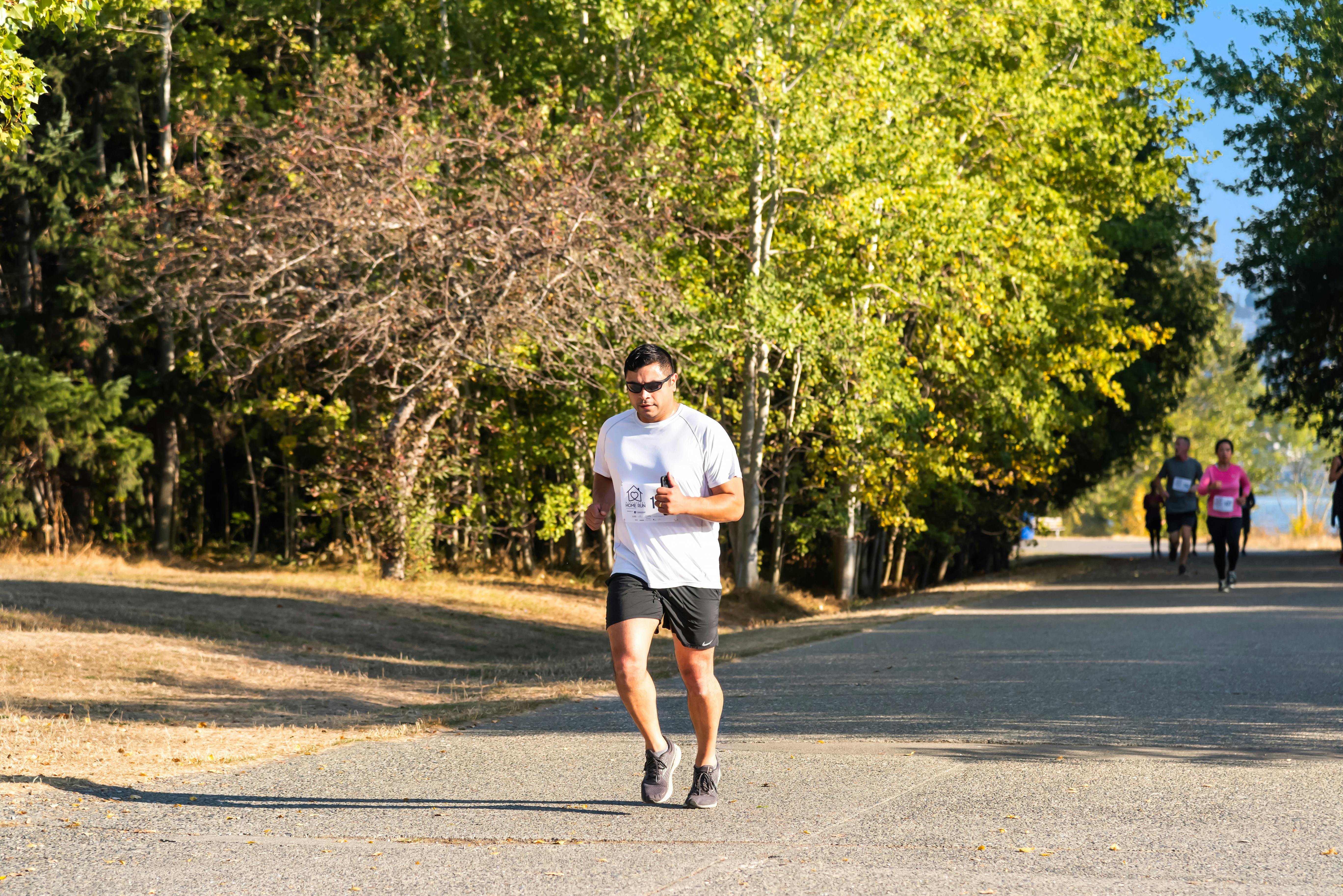 Man Running on Paved Road · Free Stock Photo