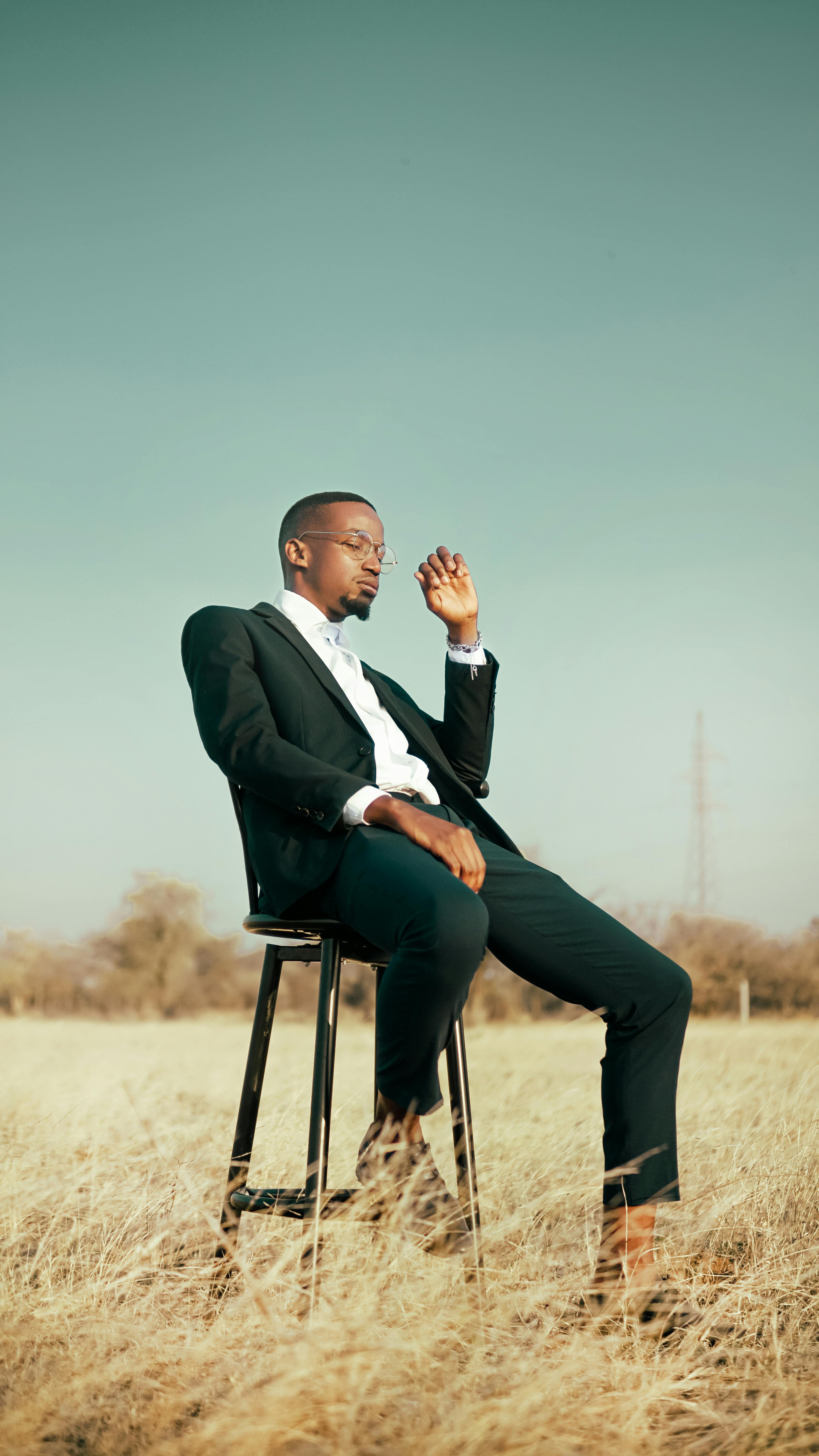 Man in Black Suit Sitting on Chair · Free Stock Photo