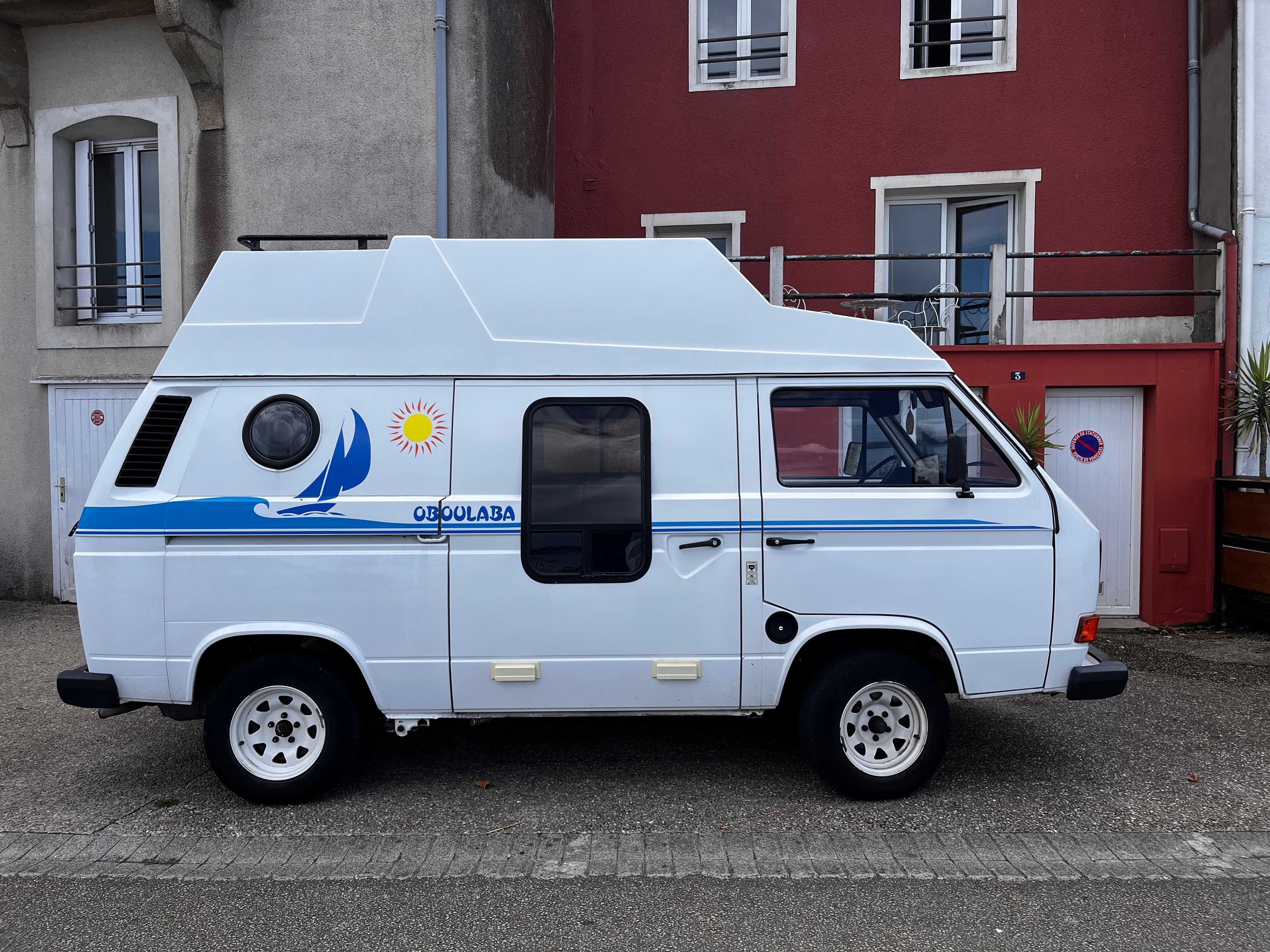 White Van Parked Beside a House · Free Stock Photo