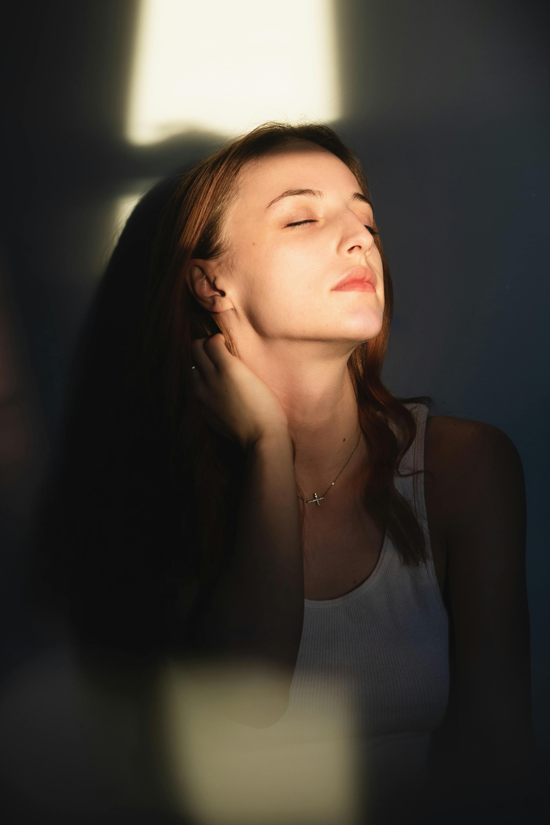 A Woman in White Tank Top Leaning on the Wall · Free Stock Photo