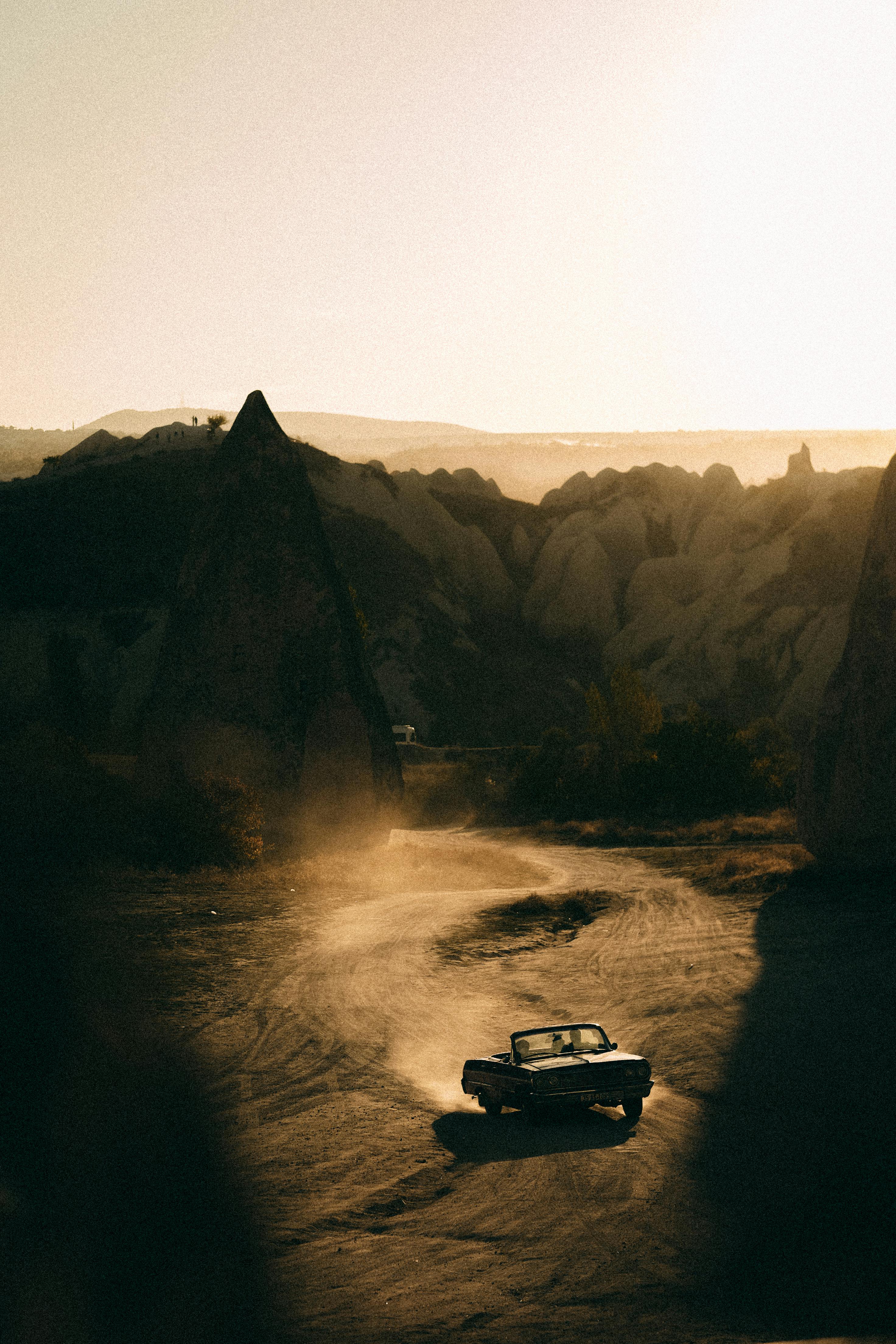 Retro Car Driving in Mountain Landscape on Sunset · Free Stock Photo
