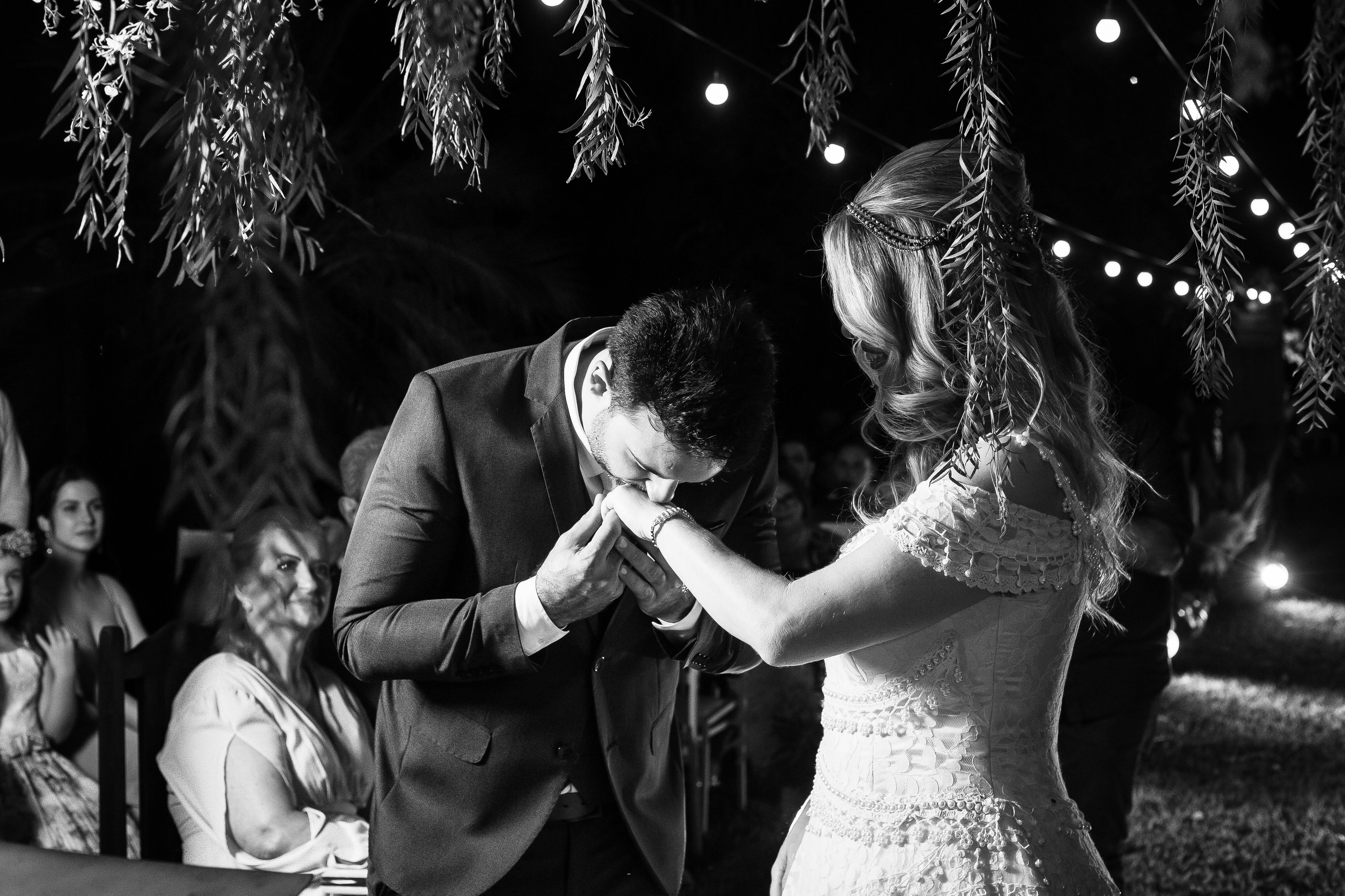 A Grayscale Photo of a Man Kissing His Partner's Hand · Free Stock Photo