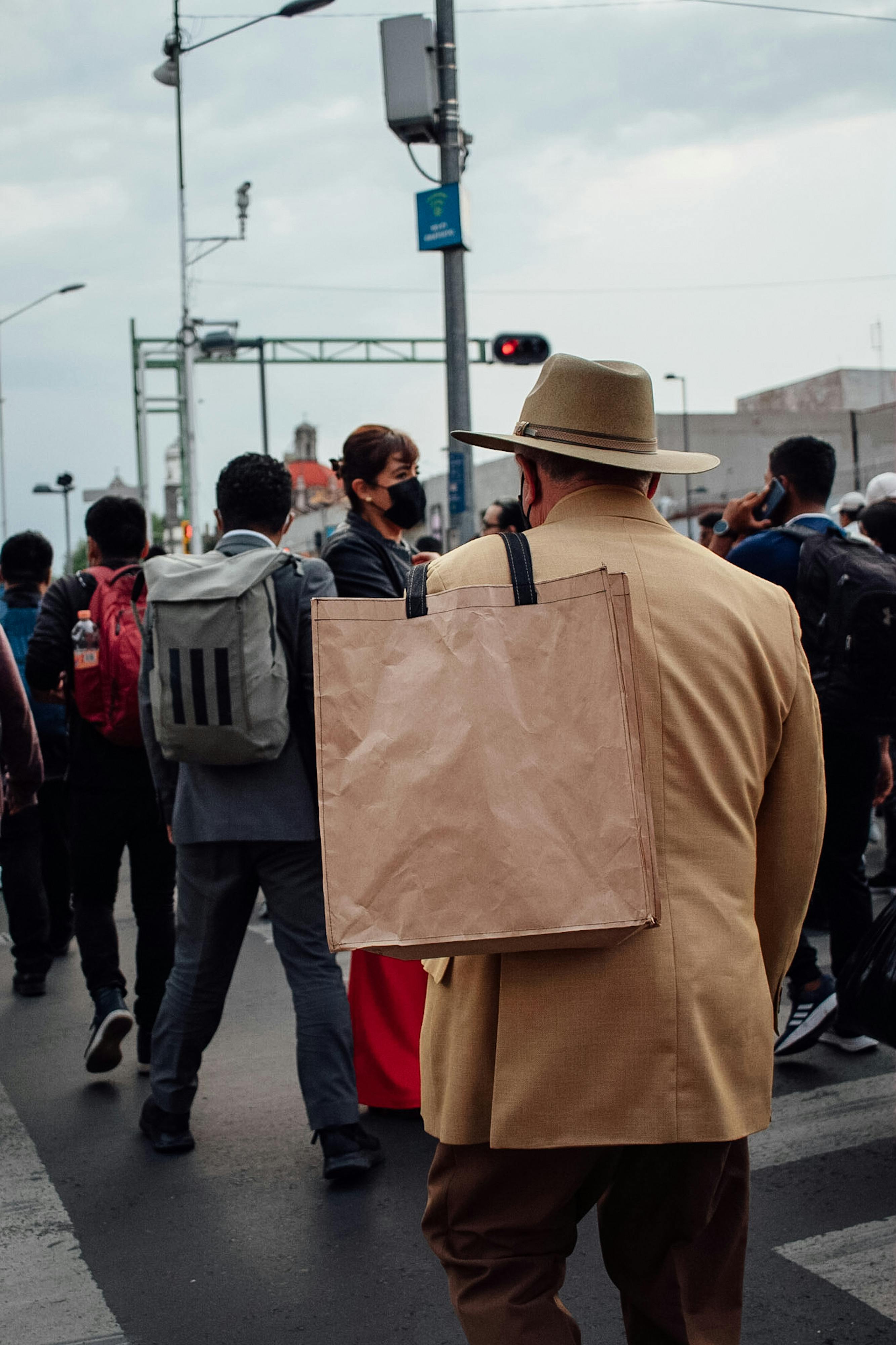 Man Standing in the Street with a Bag and Packages · Free Stock Photo