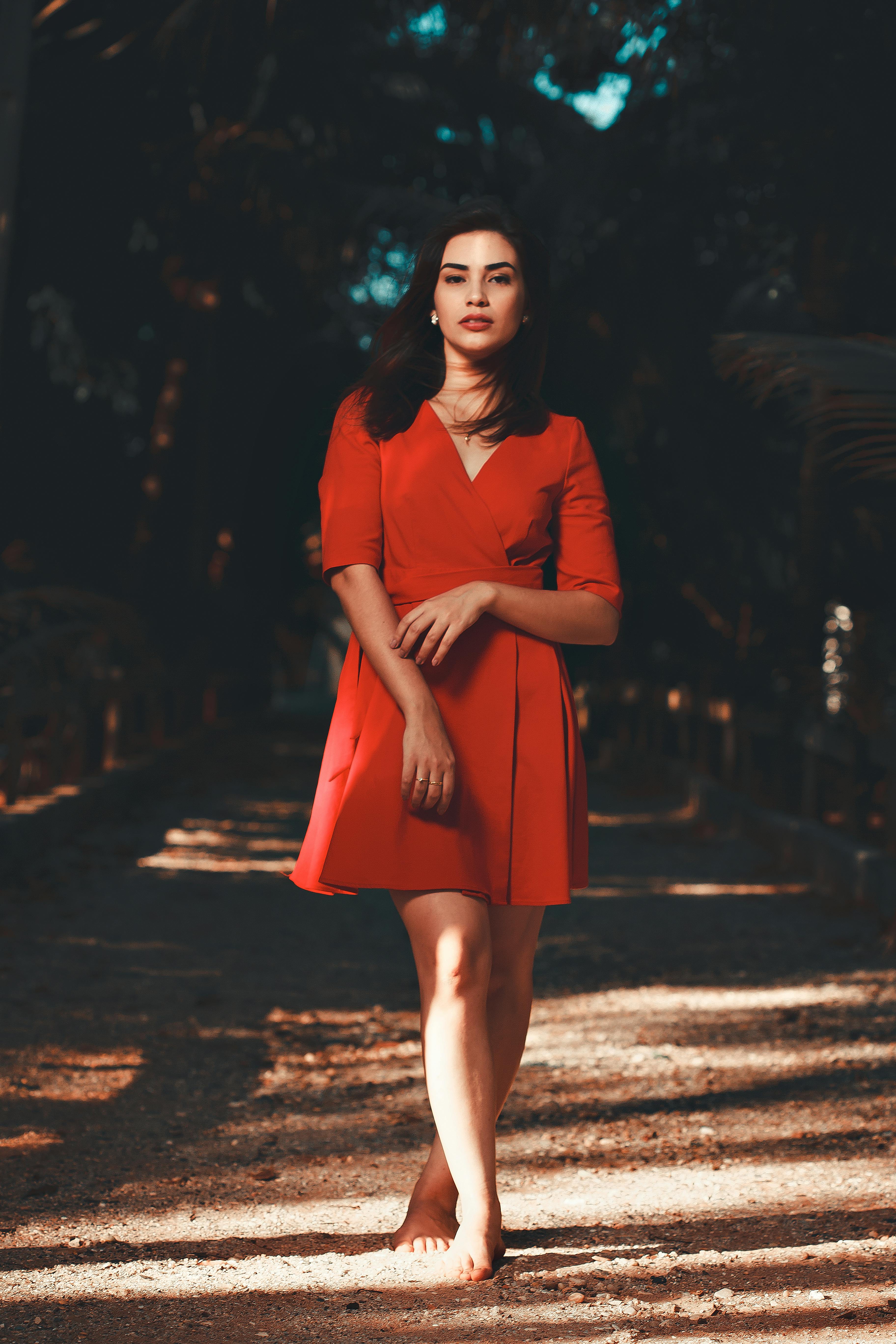 Woman in Red Dress Standing on Steps Surrounded by Boulders · Free ...