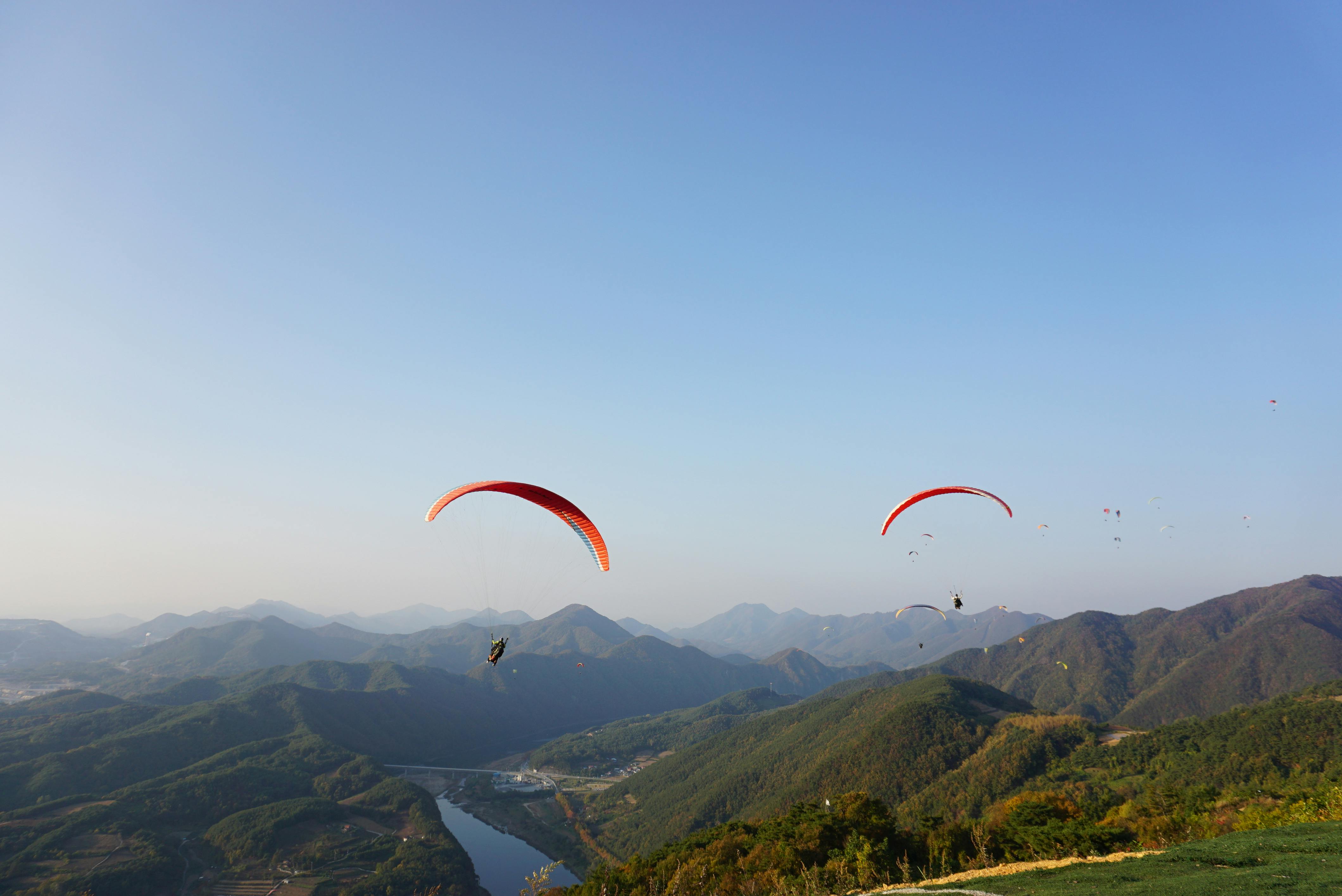 People Paragliding Above Mountains · Free Stock Photo