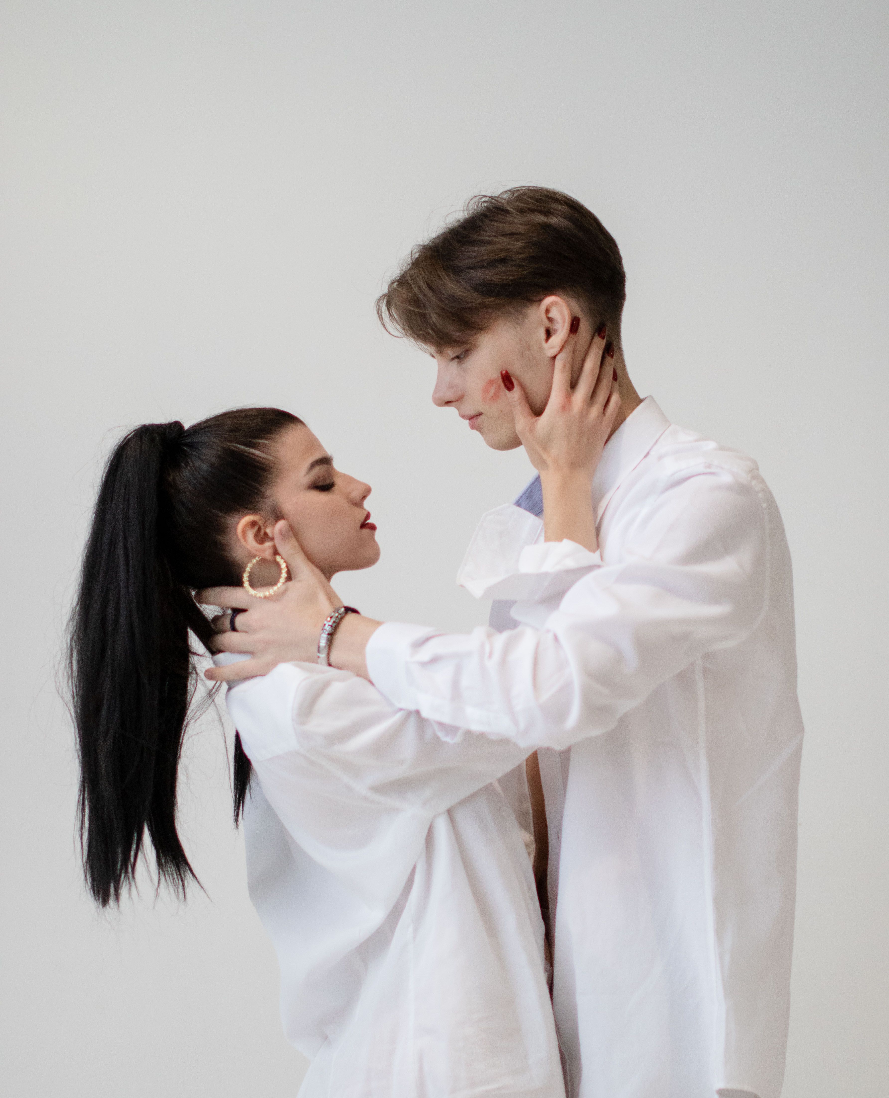 A Side View of a Couple in White Long Sleeves Facing Each Other · Free ...