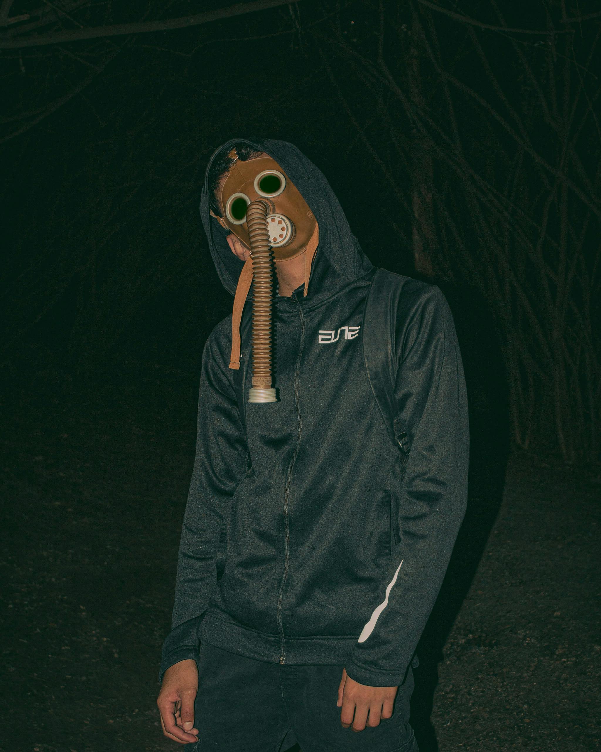 Man Wearing Uniform and Gas Mask in Room · Free Stock Photo