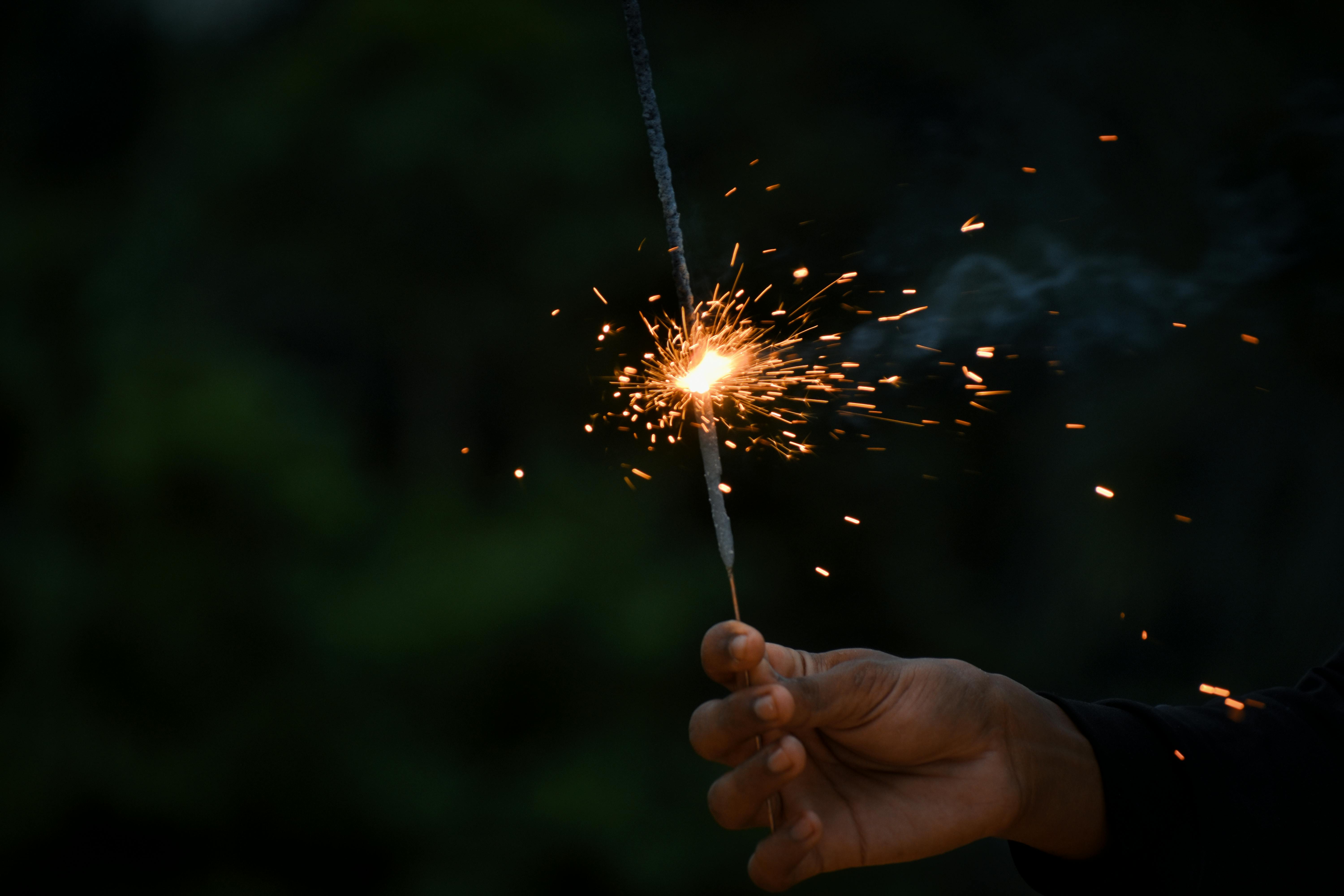Close-Up Shot of a Person Holding a Burning Sparkle · Free Stock Photo