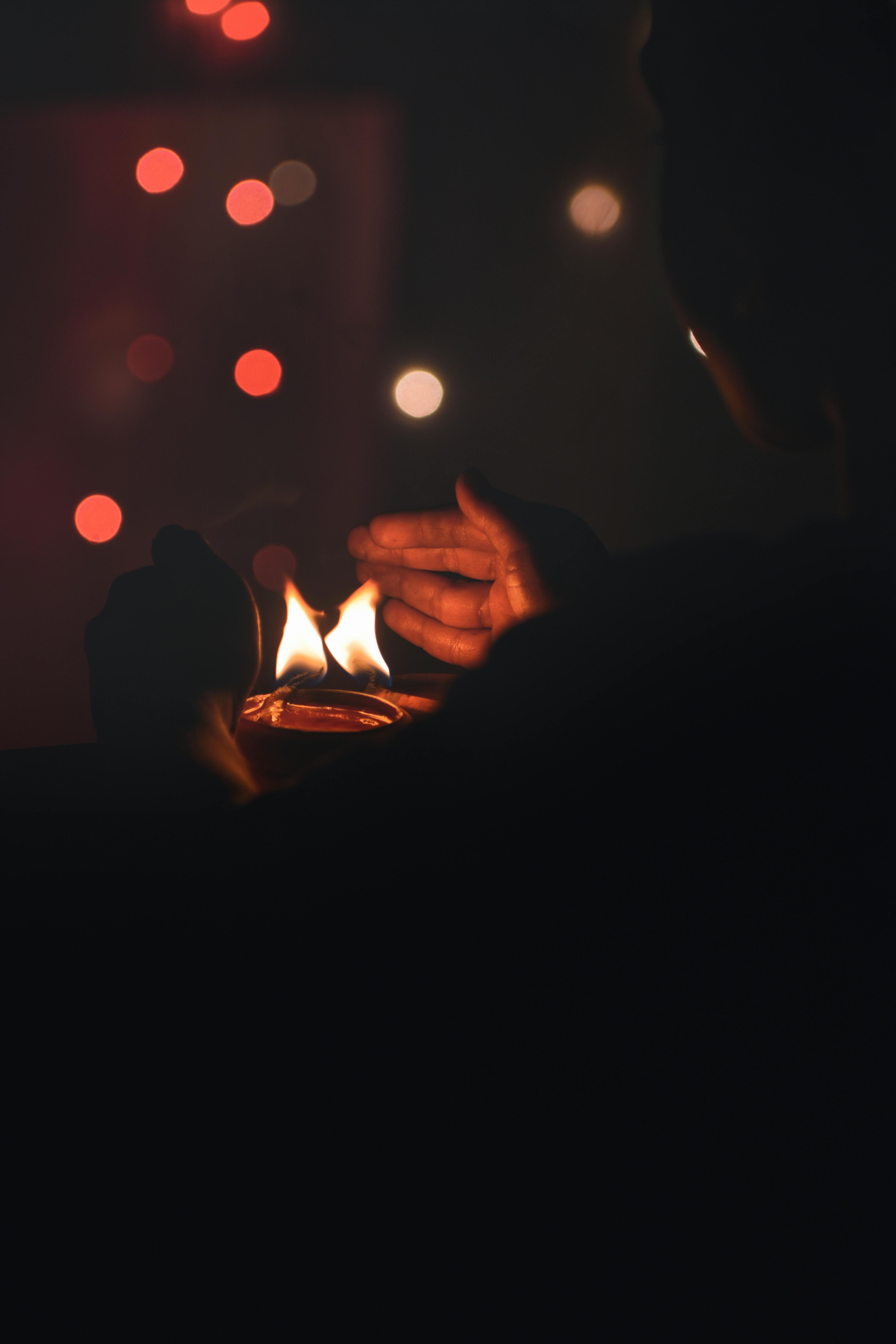 Man Hands over Candles · Free Stock Photo