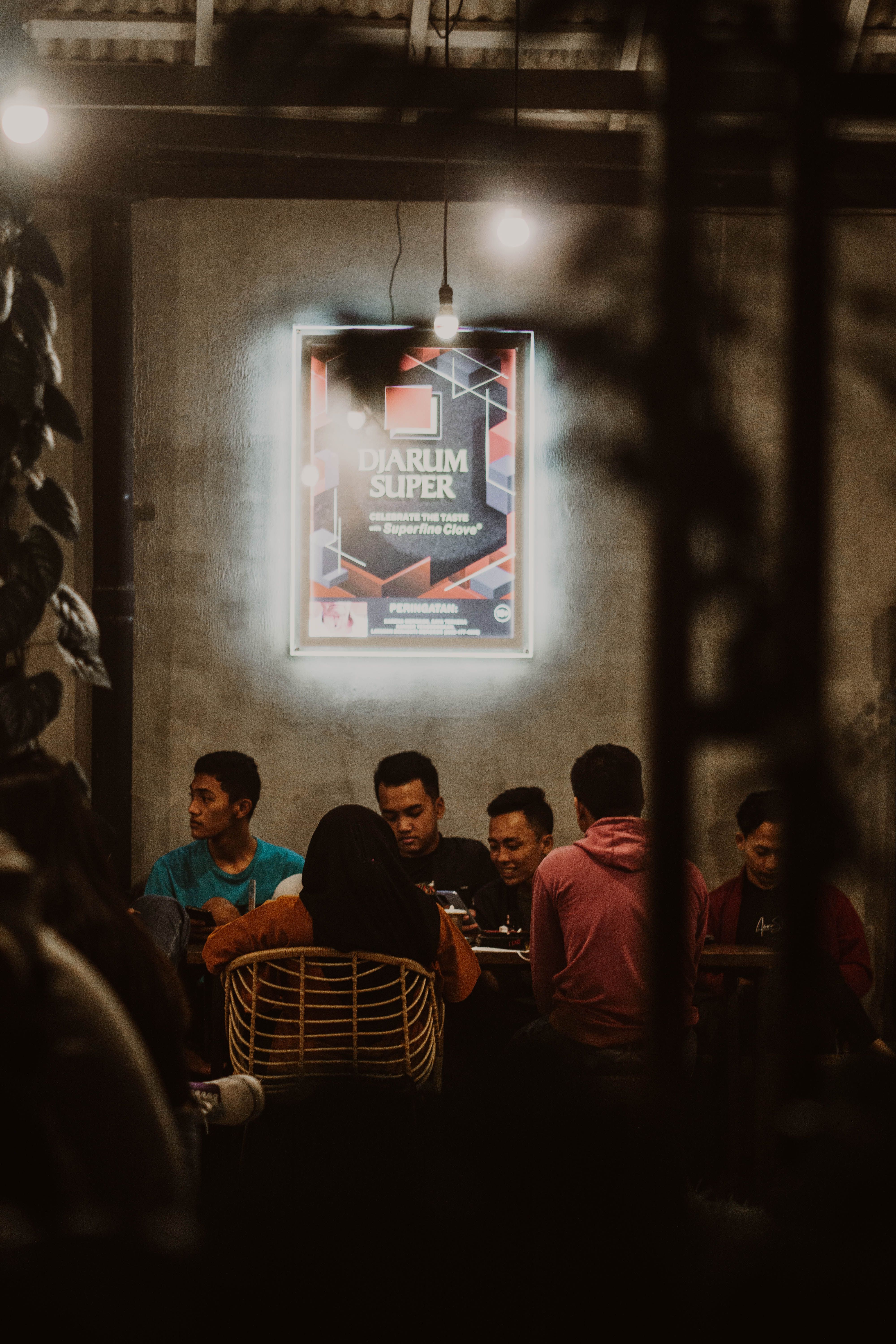 People Gossiping While Sitting on the Wooden Table · Free Stock Photo