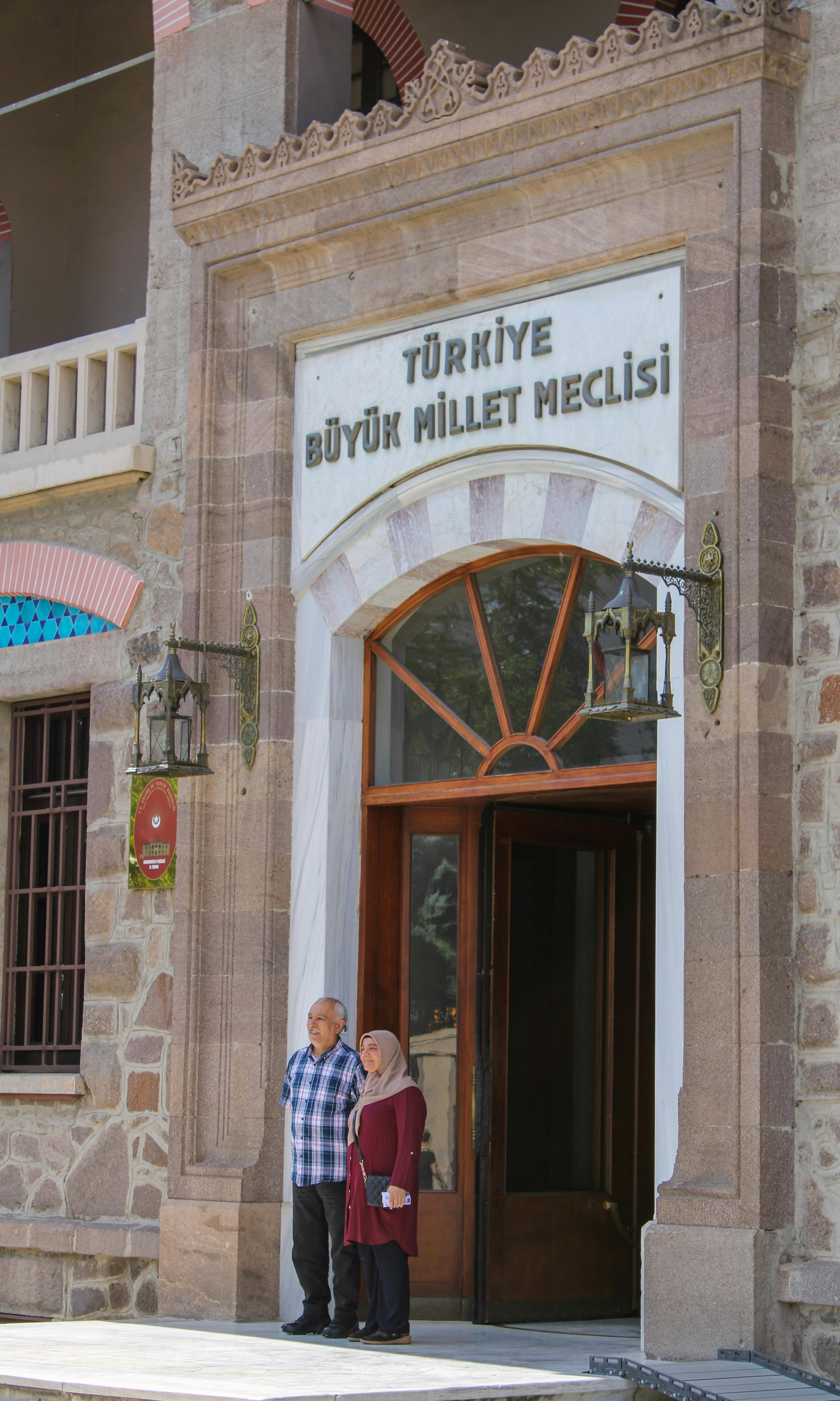 A Couple Standing in Front of the Grand National Assembly of Turkey ...