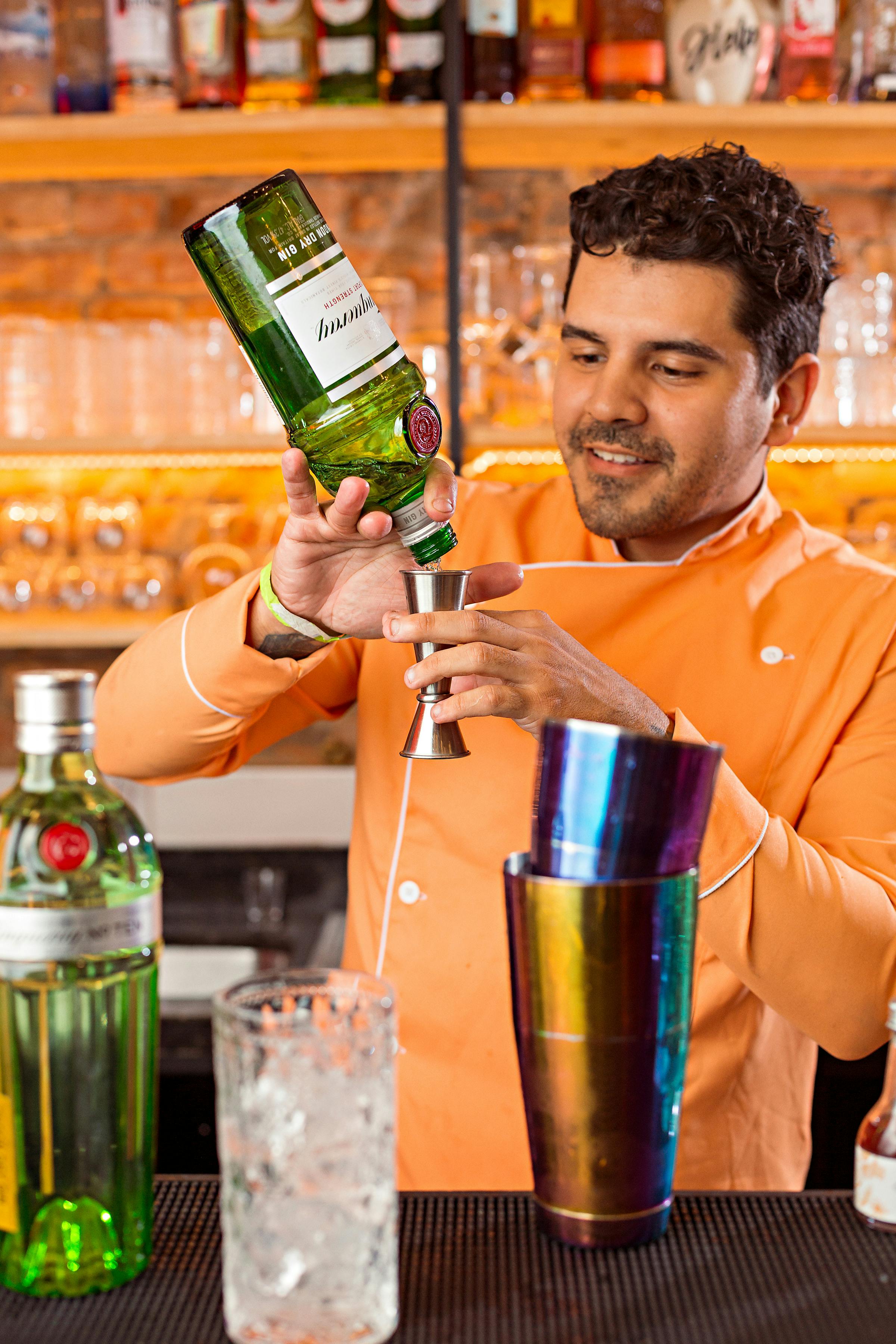 Person Pouring Brown Liquid on Clear Drinking Glass · Free Stock Photo