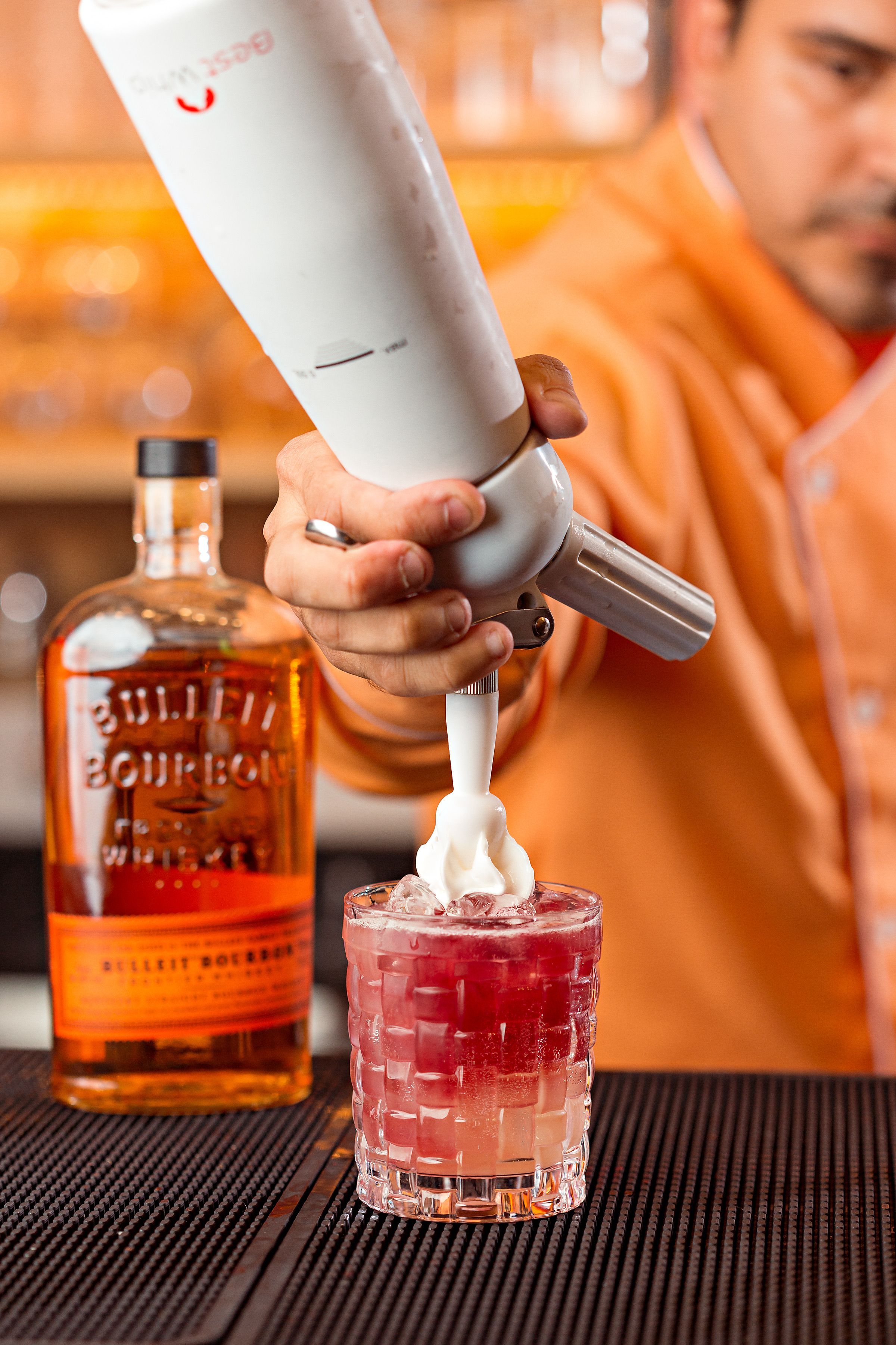 A Person Putting Cream on Red Drink · Free Stock Photo