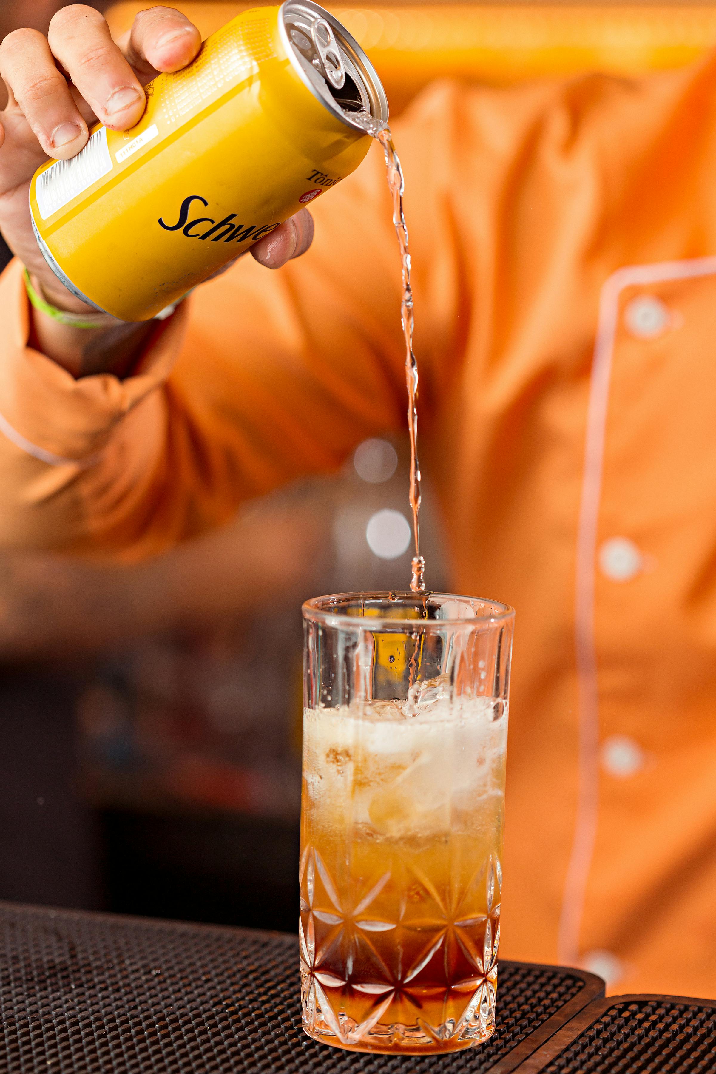 Person Pouring Drink into Glasses · Free Stock Photo