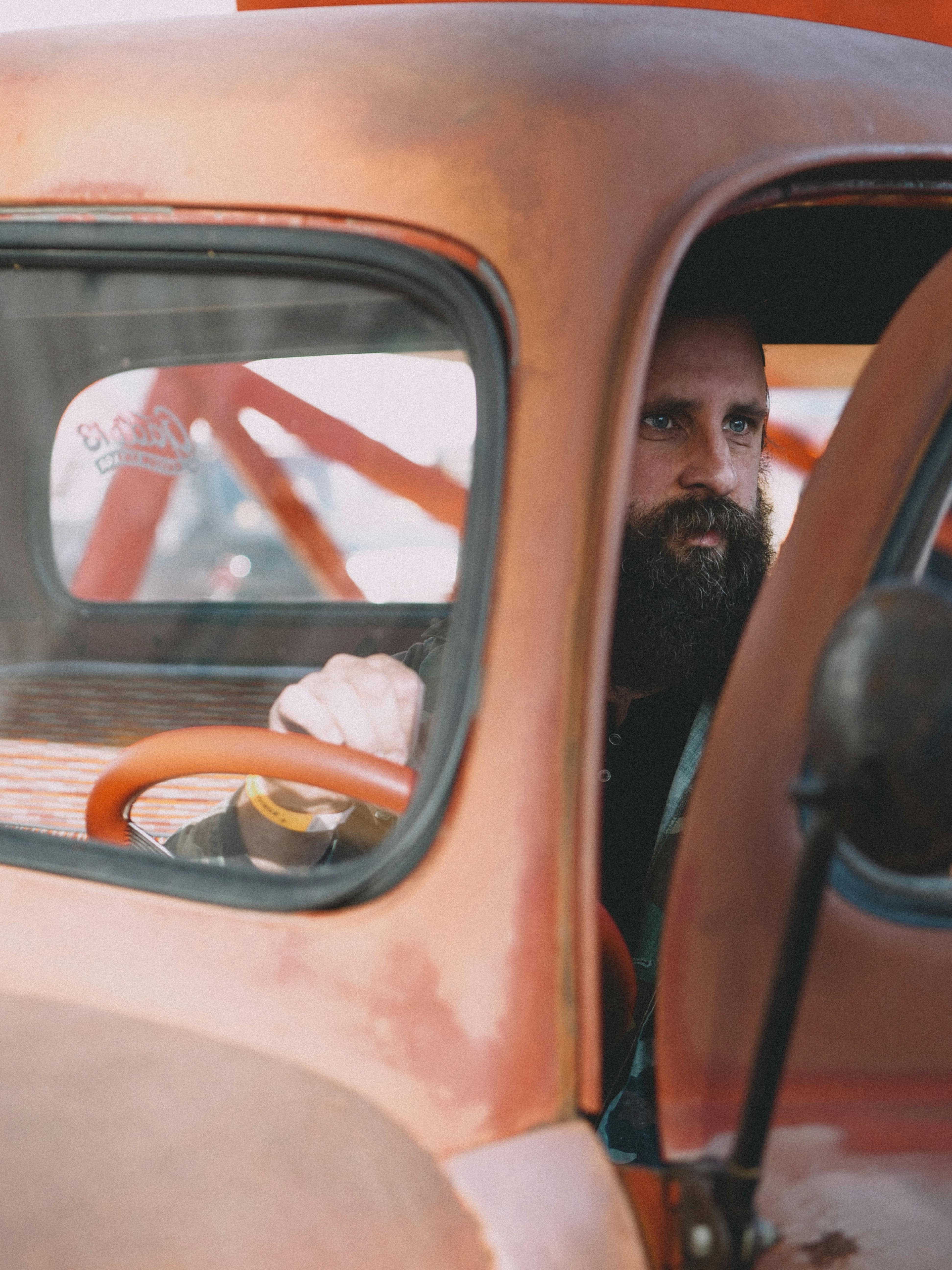 Man Posing in Vintage Car · Free Stock Photo