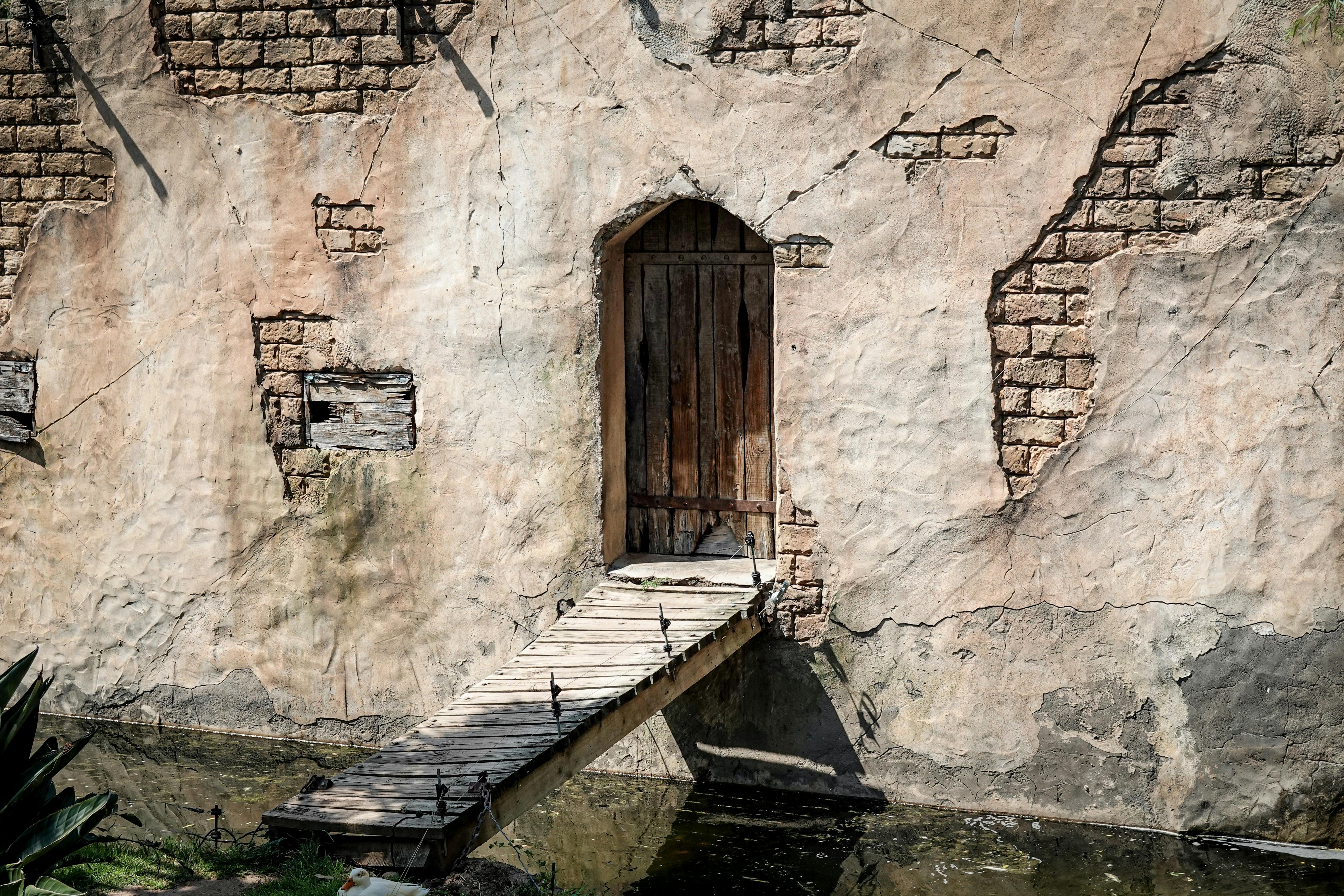 A Concrete Wall with Wooden Bridge · Free Stock Photo