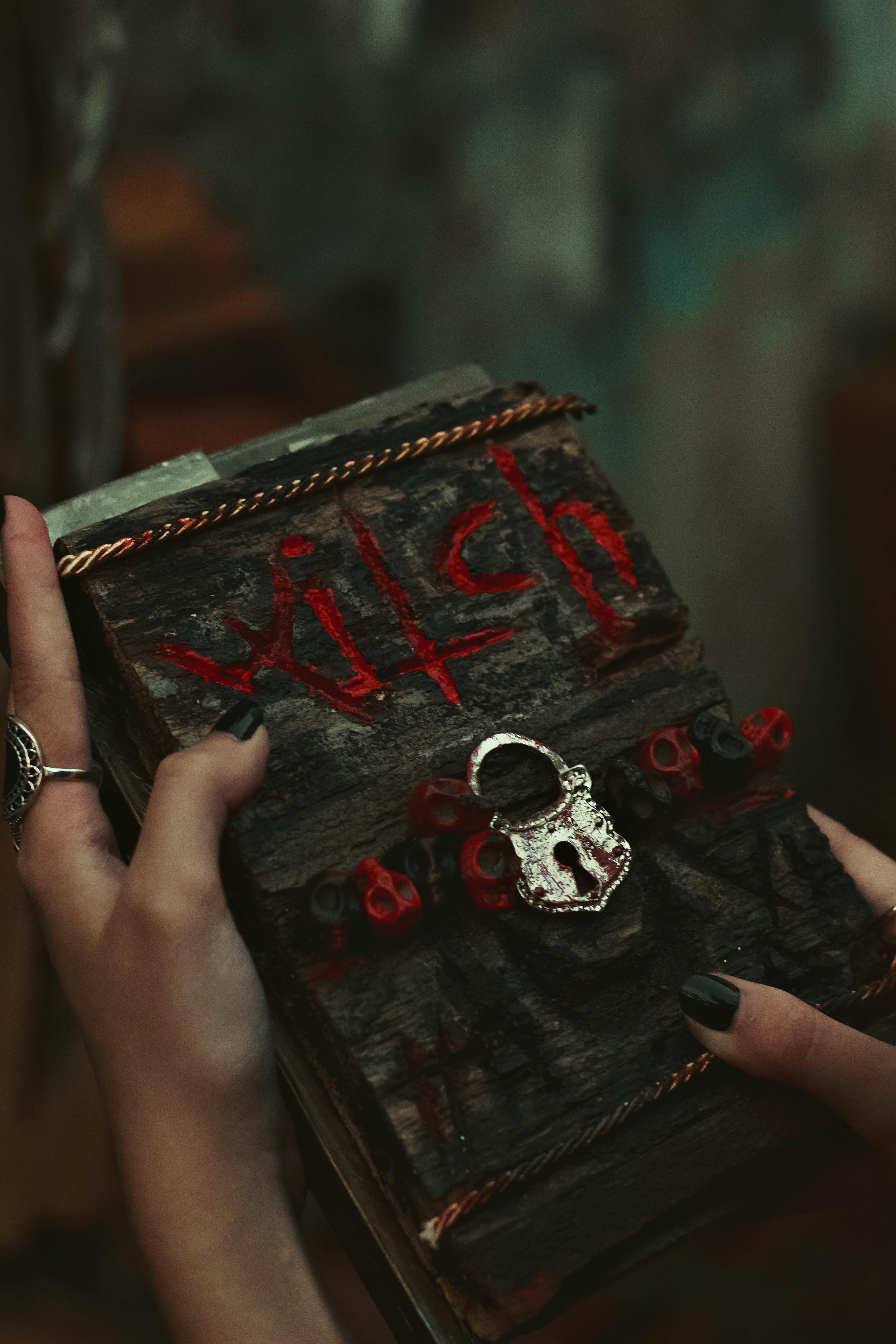 Hands Holding Locked Spellbook · Free Stock Photo