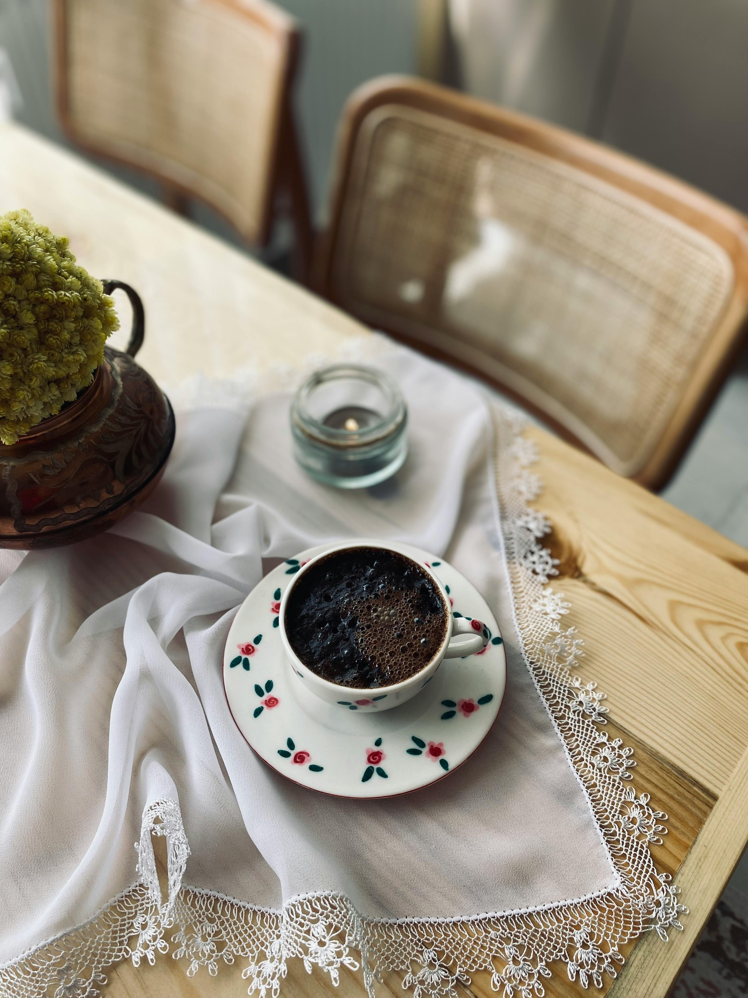 Coffee Cup and Candle on Table · Free Stock Photo